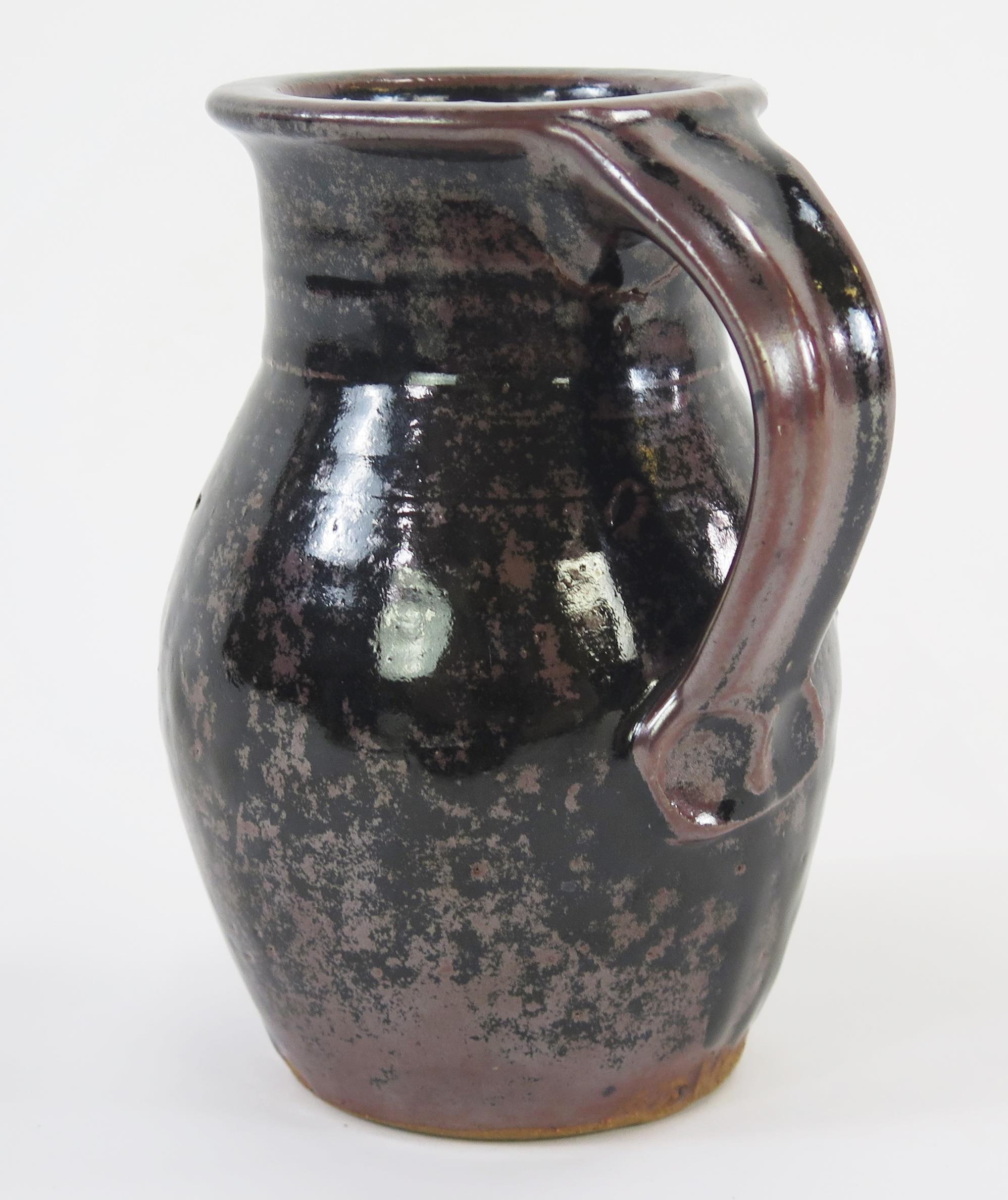 A Leach Pottery stoneware jug, of ovoid form with treacle glaze ...