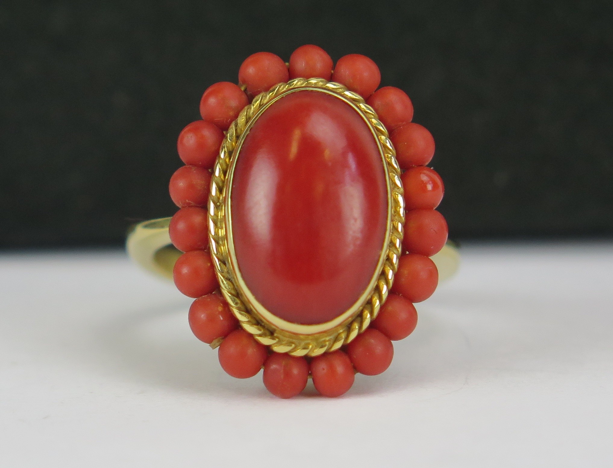 An 18ct yellow gold and coral cluster ring, c. 21x16mm head, size M.5 ...