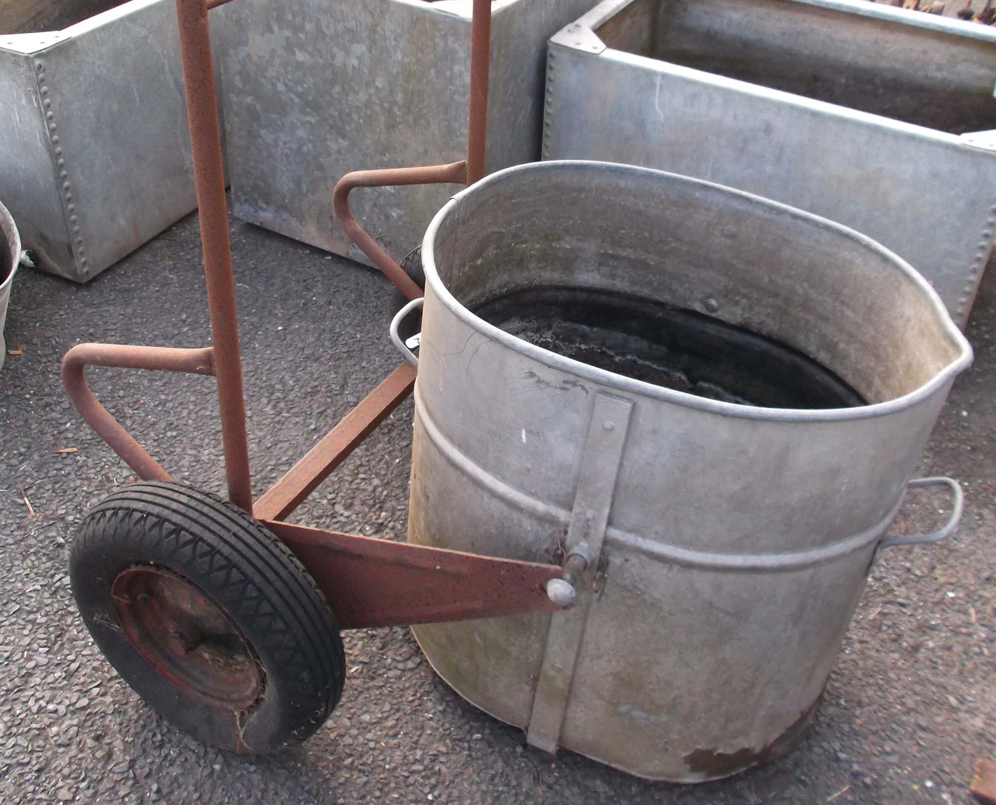 A vintage galvanised tar bucket with trolley