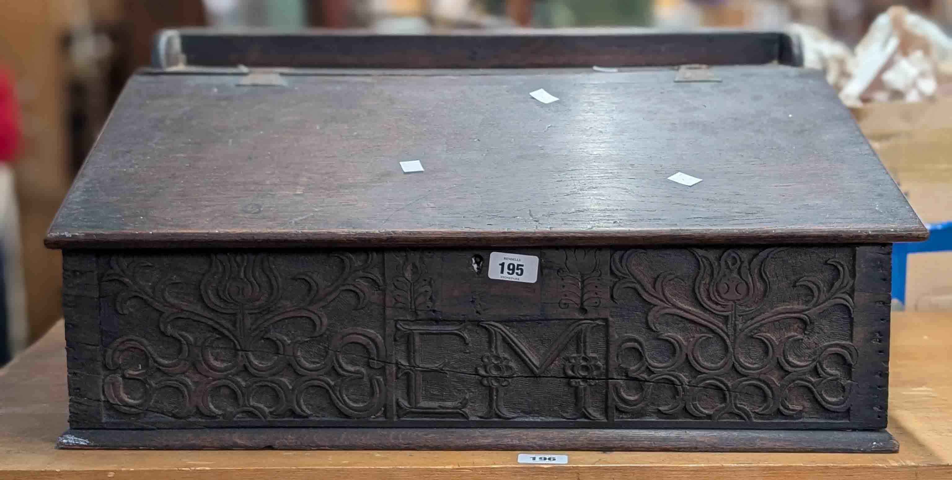 A 67cm antique oak slope-fronted bible box with carved 'E.M.' initials ...