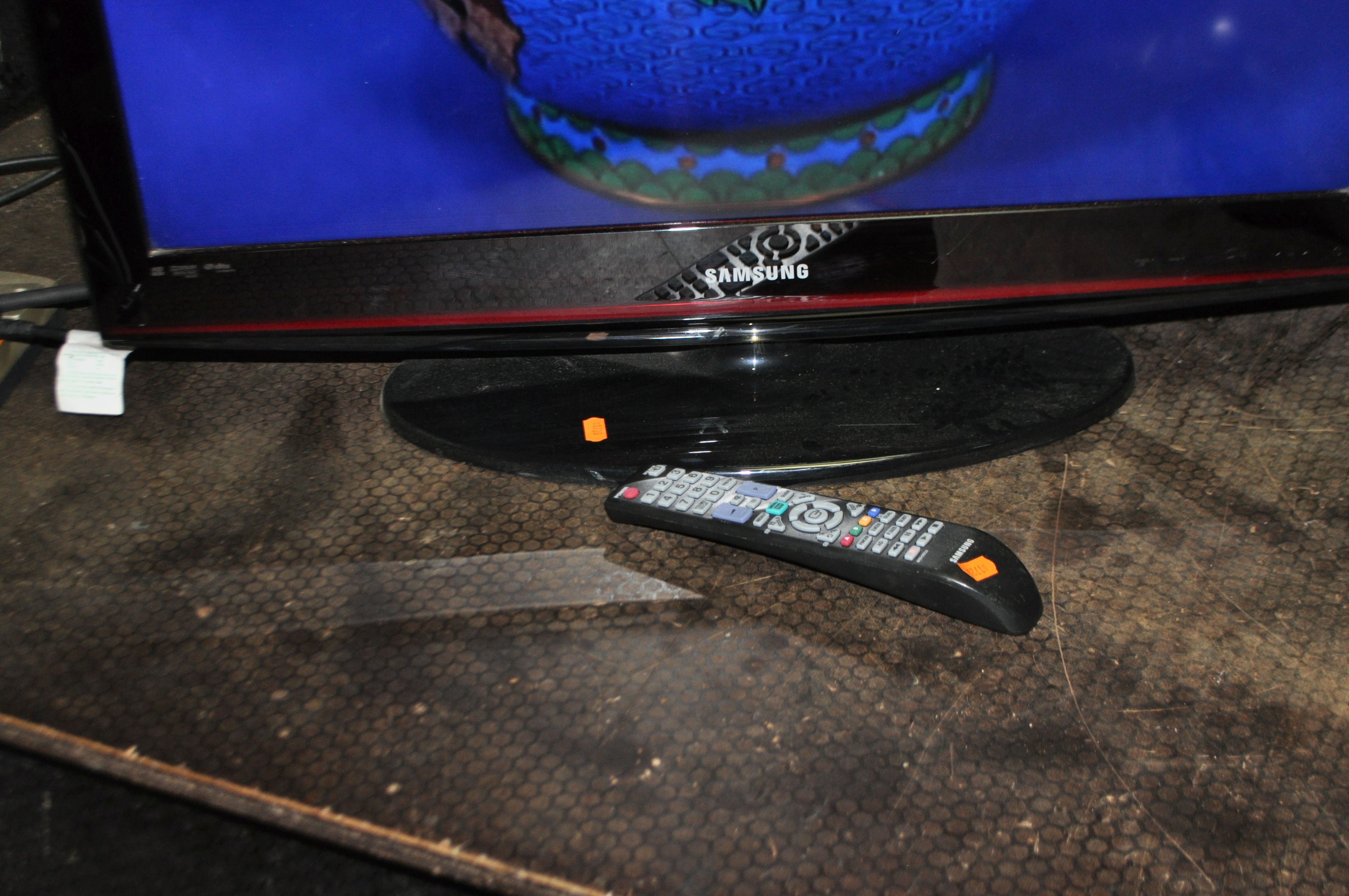 A SAMSUNG LE32C450E1W 32in TV with remote and a Oneday handheld vacuum ...