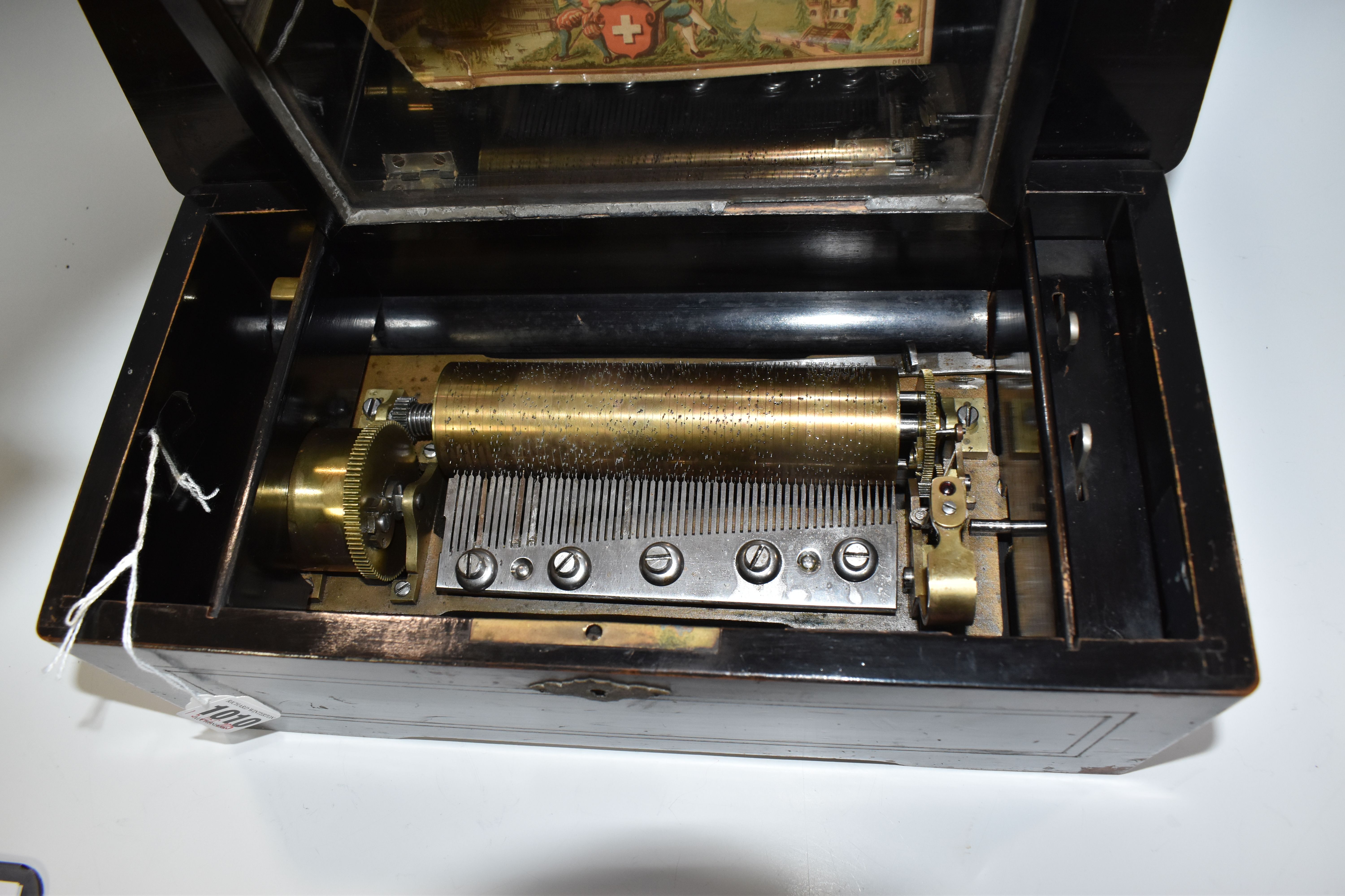 A NINETEENTH CENTURY CYLINDER MUSIC BOX, plays six airs, inlaid flower ...