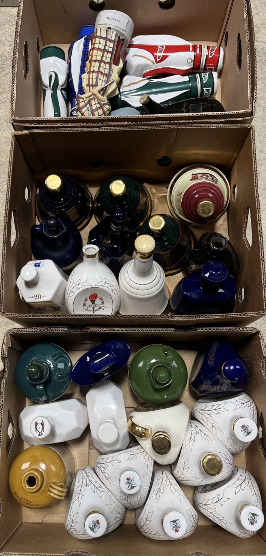 Large collection of empty whisky flasks/decanters, incl. commemorative whisky 'In commemoration o