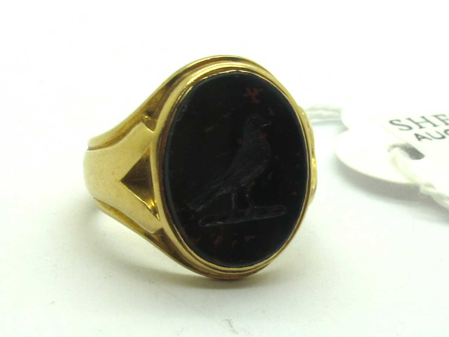 An 18ct Gold Bloodstone Inset Signet Ring, the oval panel with engraved ...
