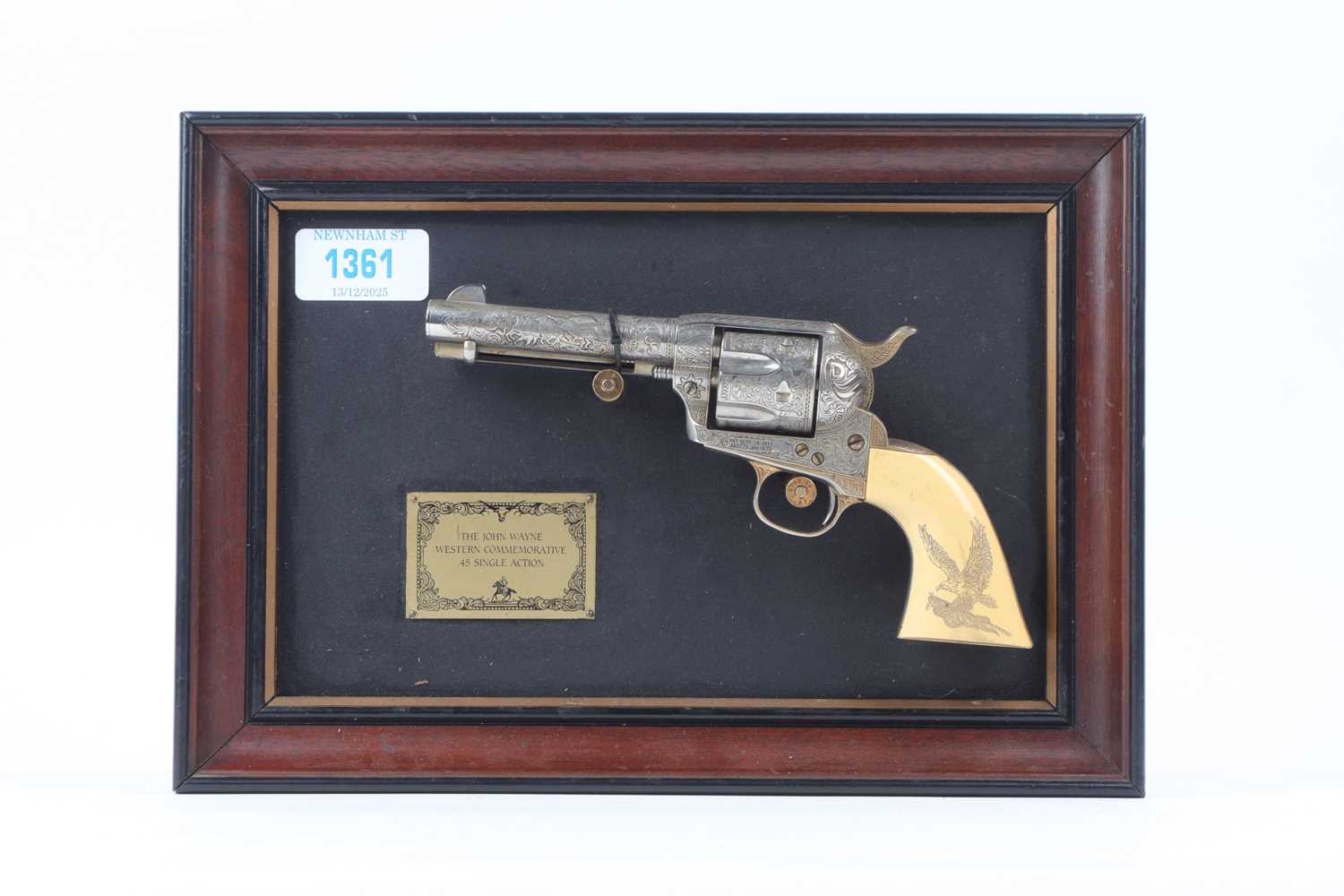 Replica John Wayne Colt Single Action Army revolver, on wall display