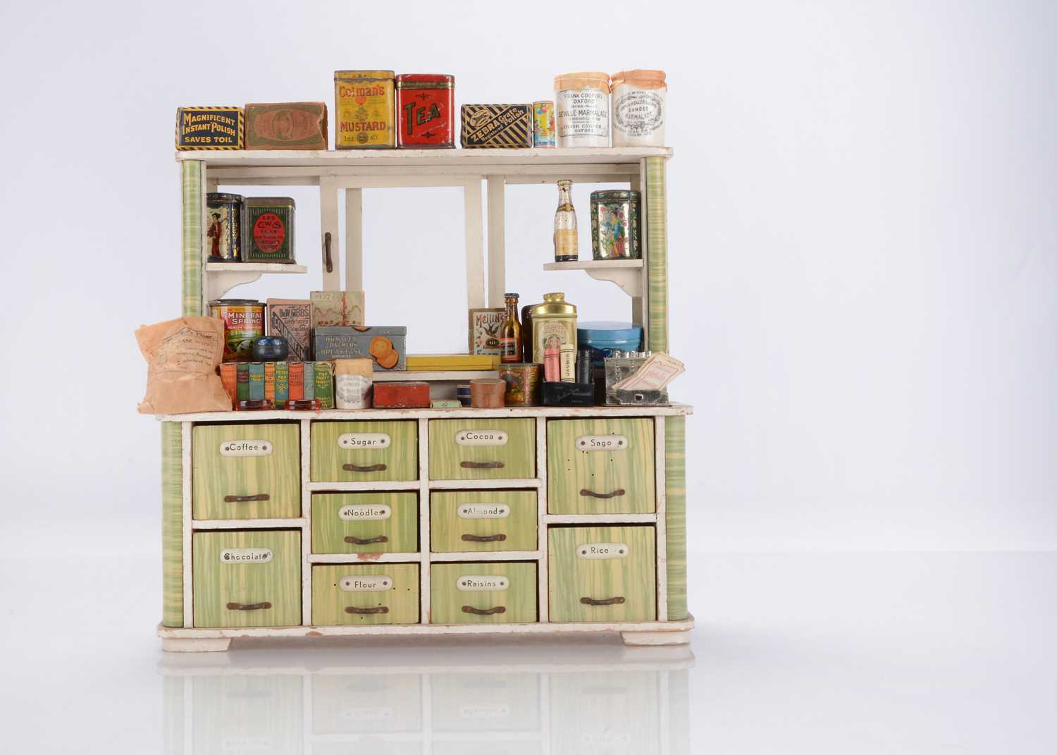 A 1930s German wooden toy shop, painted white with green striped draws ...