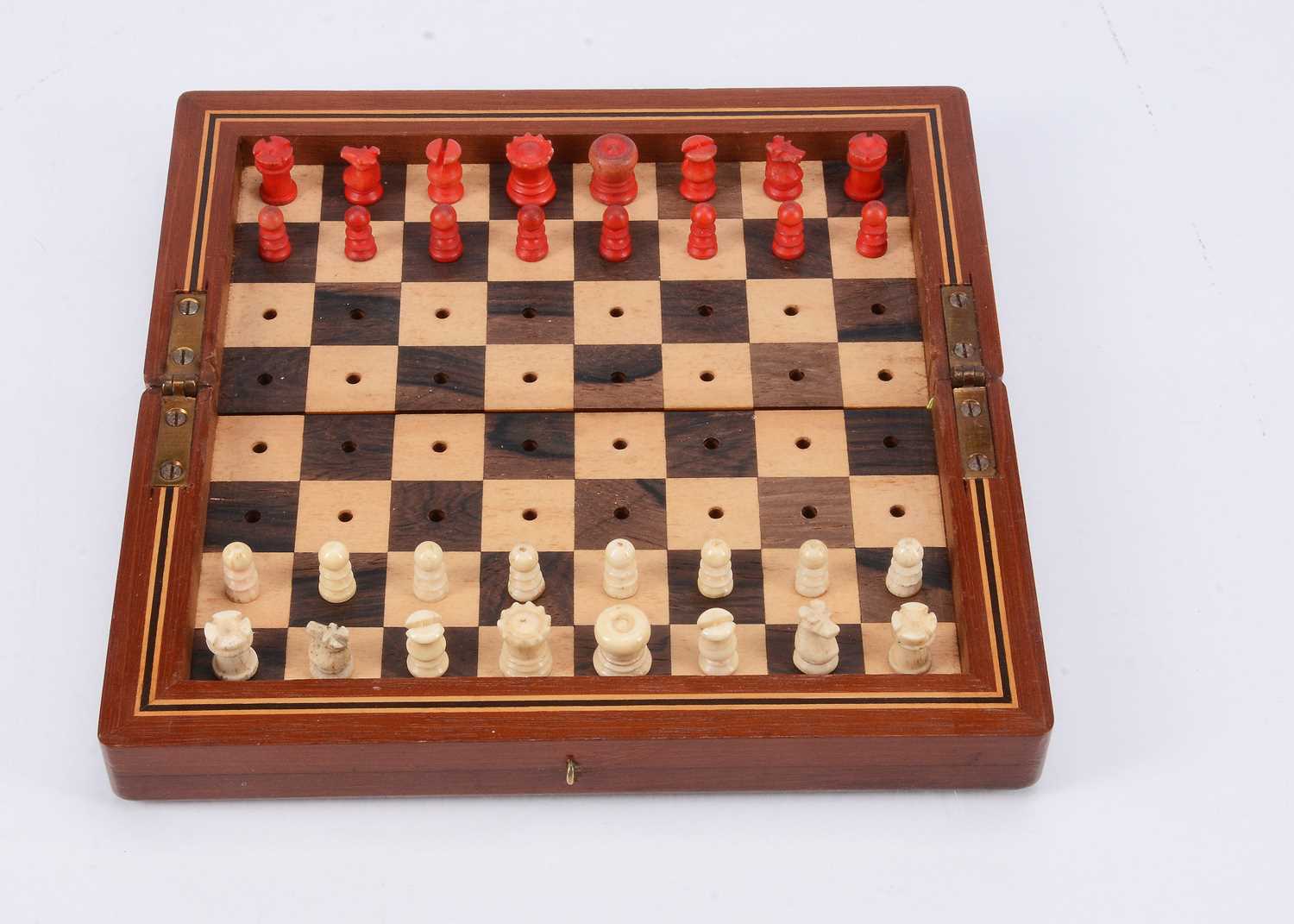 An early 20th century traveling chess set, with turned bone pieces ...