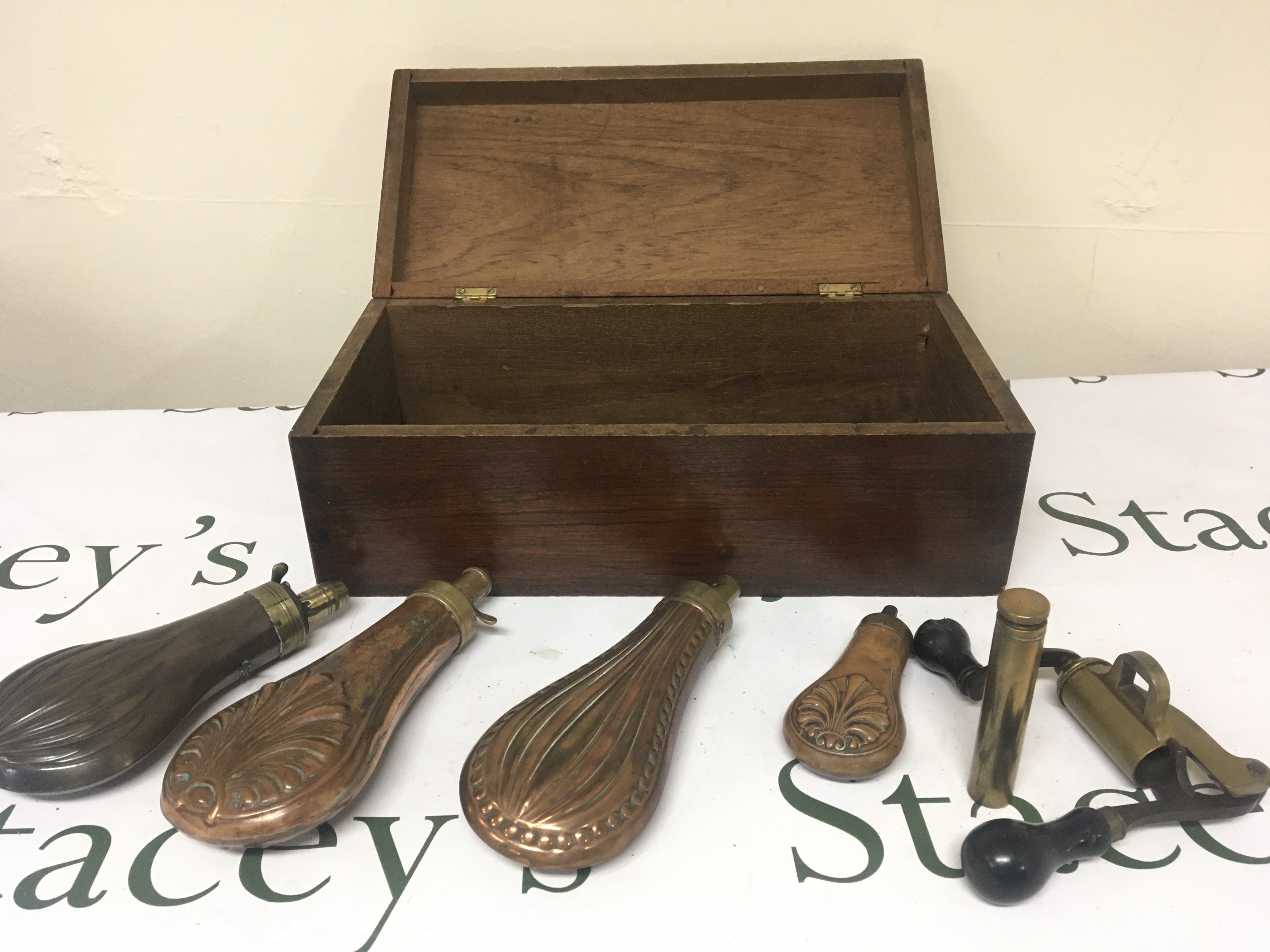 Four 19th century Copper powder flasks and cartridge loader all in a ...