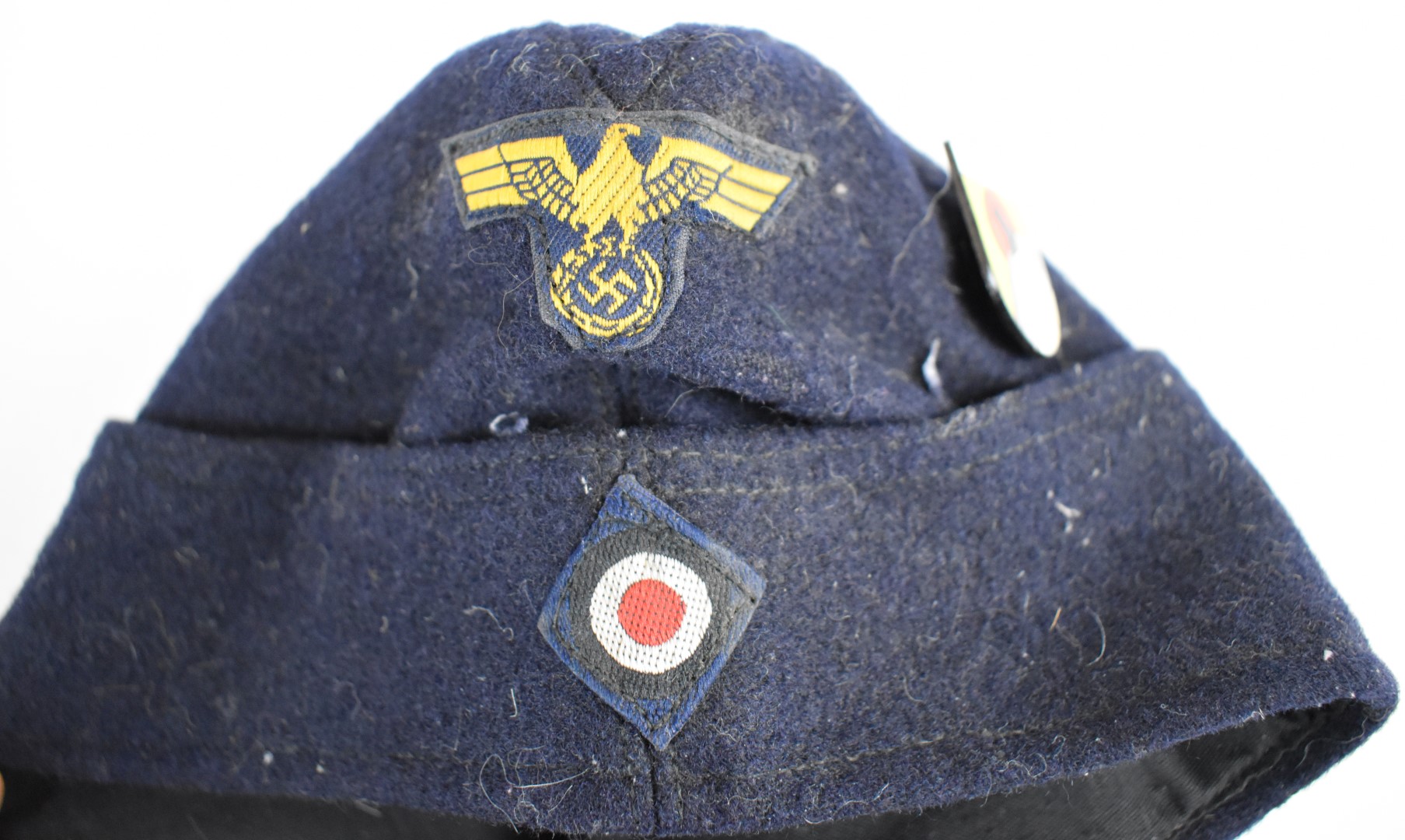 Three German military caps with printed marks, 'August Schellenberg ...