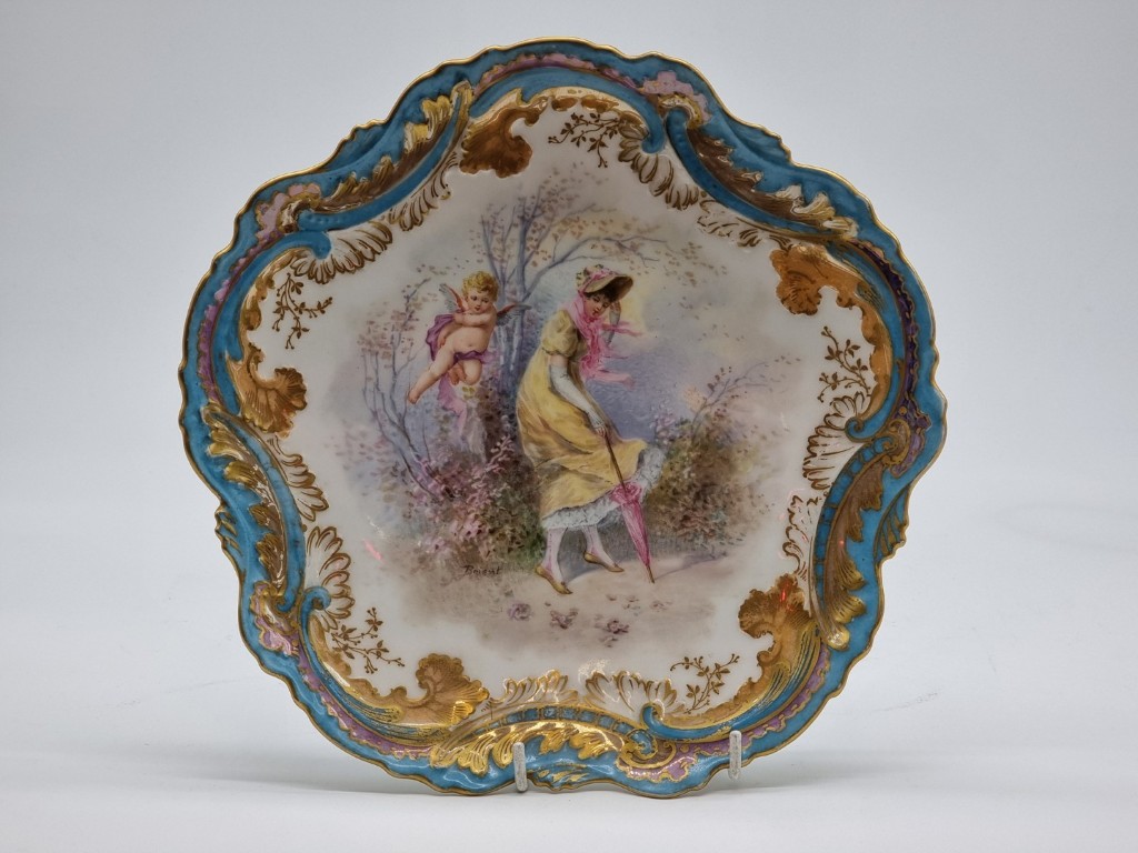 A Sevres style cabinet plate, painted with an Edwardian lady and a ...