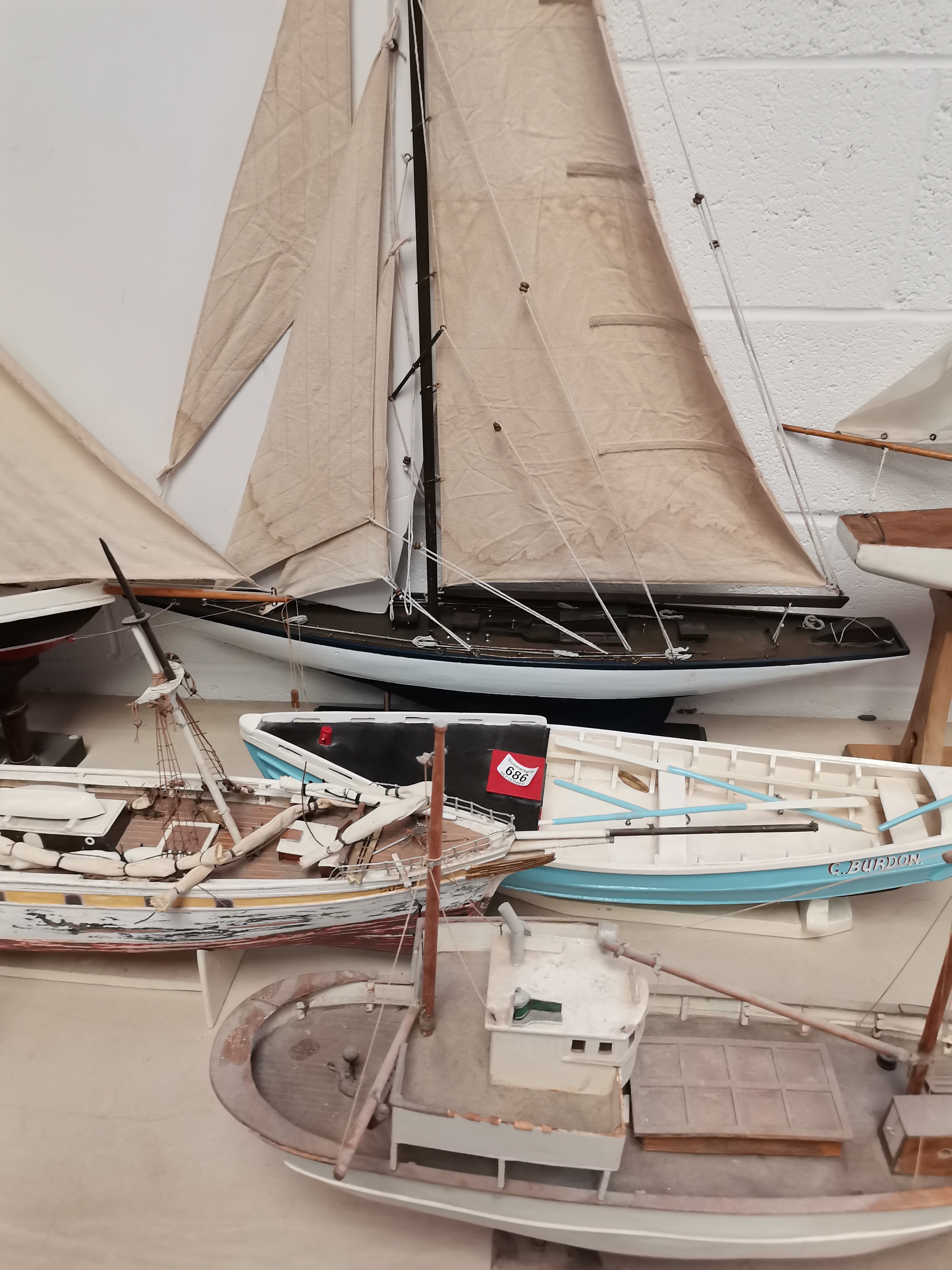 x3 model sailing boats on stands