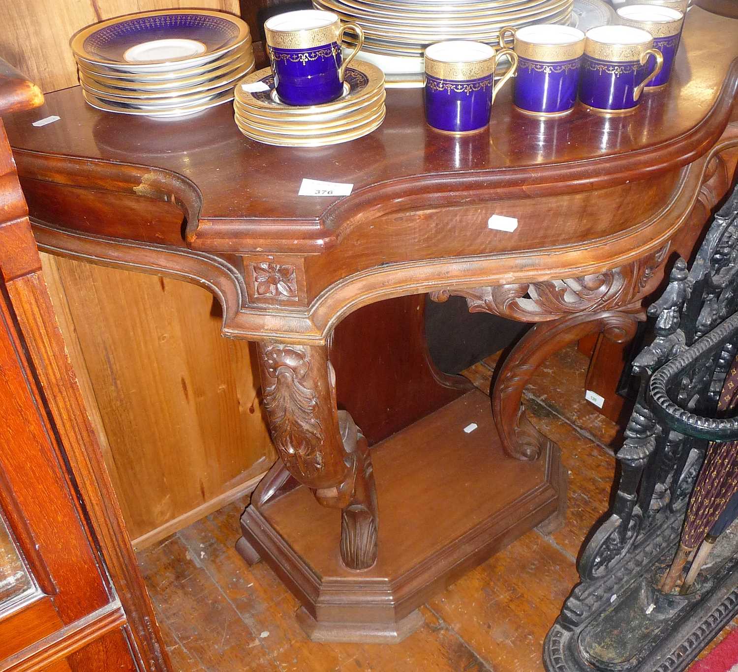 Reproduction mahogany console/hall table with shaped top above carved legs
