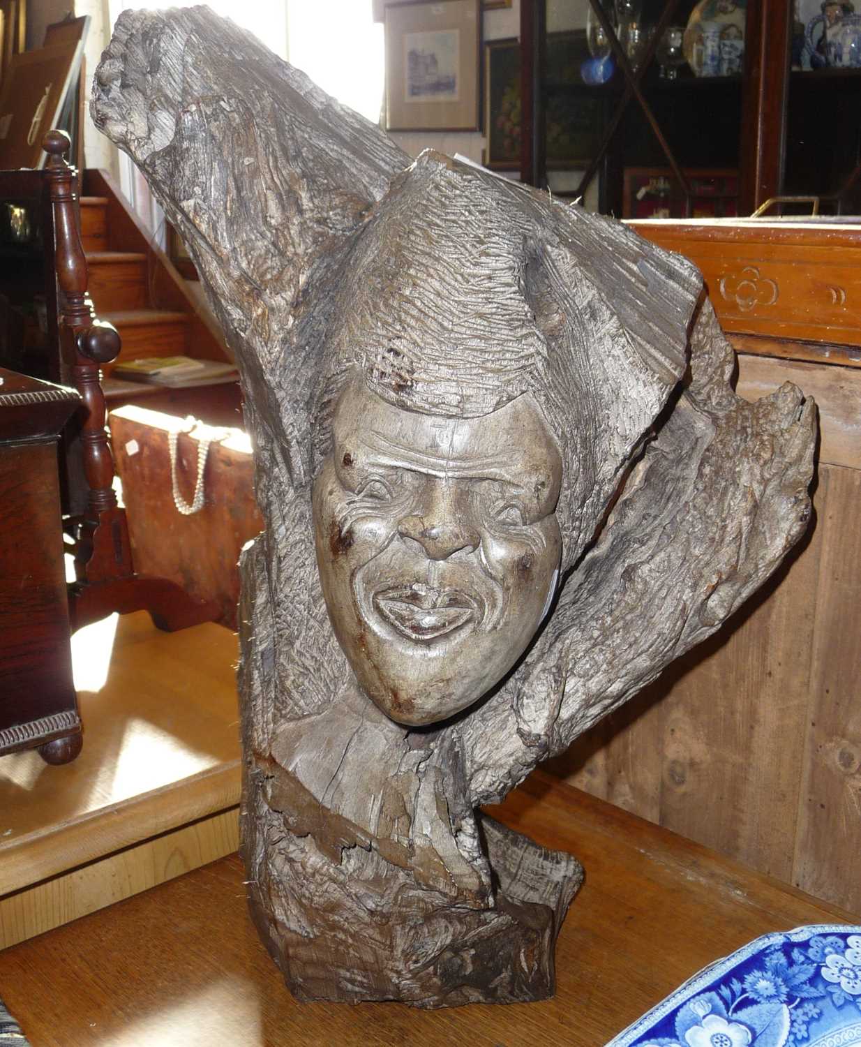 Large root carving of an African face