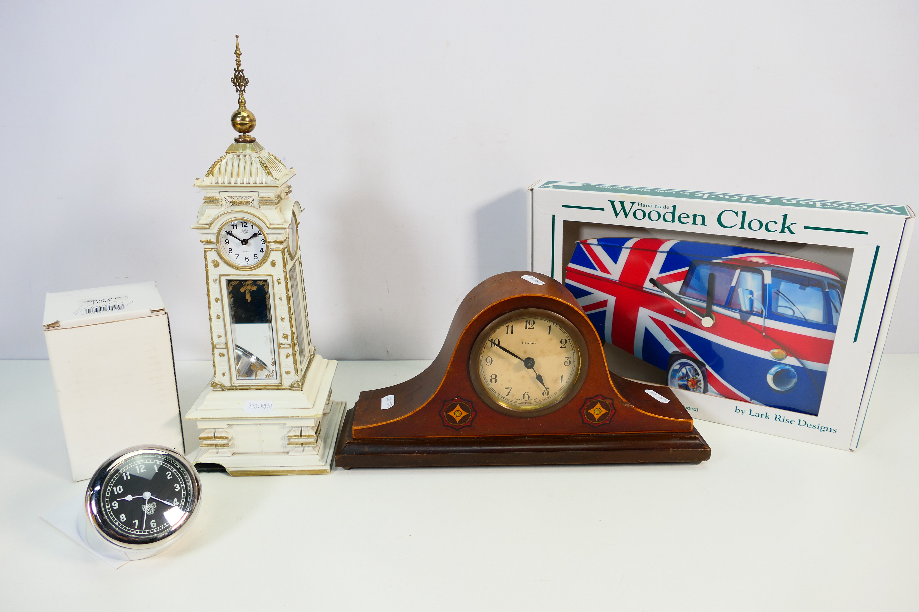 A collection of clocks to include a mantel clock, boxed wall clock in ...