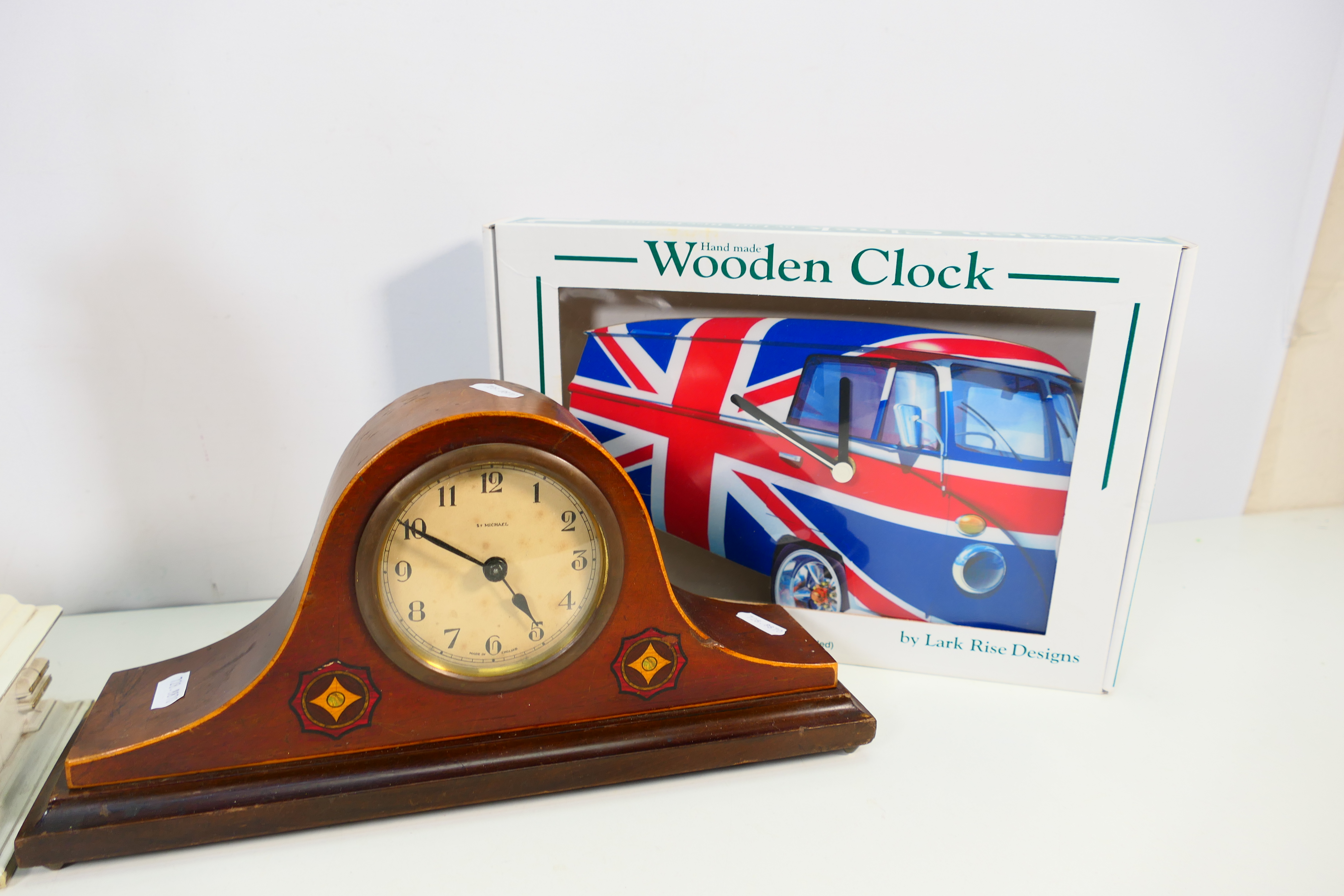 A collection of clocks to include a mantel clock, boxed wall clock in ...