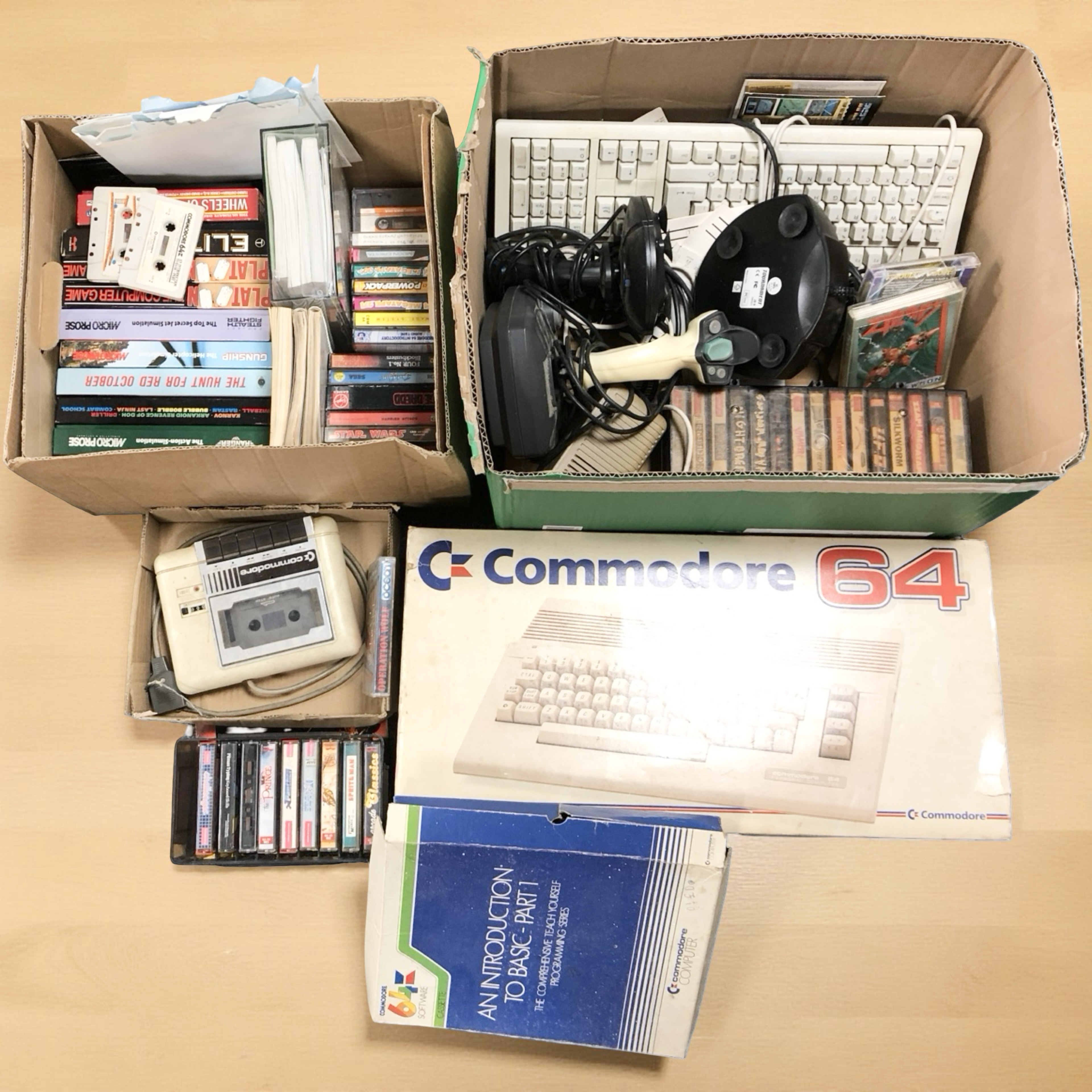 A Commodore 64 in box, related items, cassettes, etc. (2 boxes)