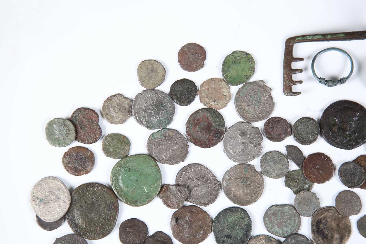 A collection of Roman antiquities, including coins, pottery fragments ...