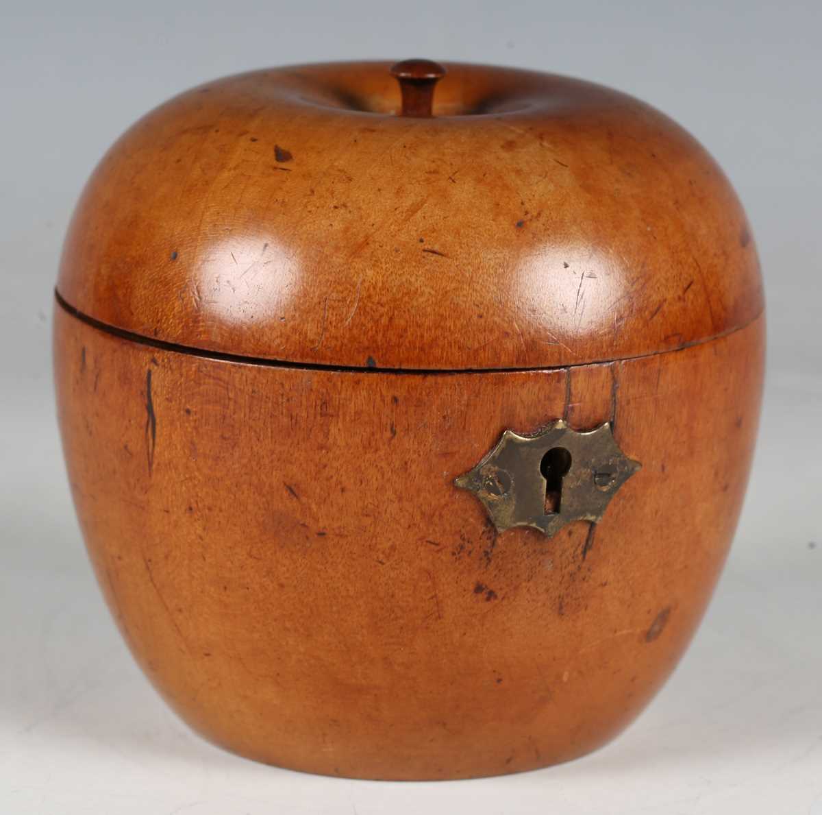 A George III turned apple tea caddy, the hinged lid with carved stalk ...