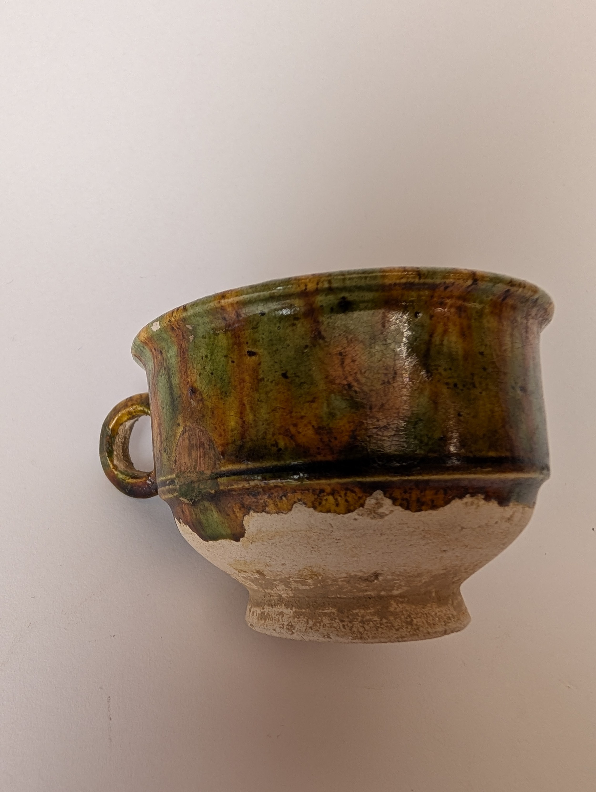 A Chinese Tang style sancai cup, the glazes covering the top half and ...