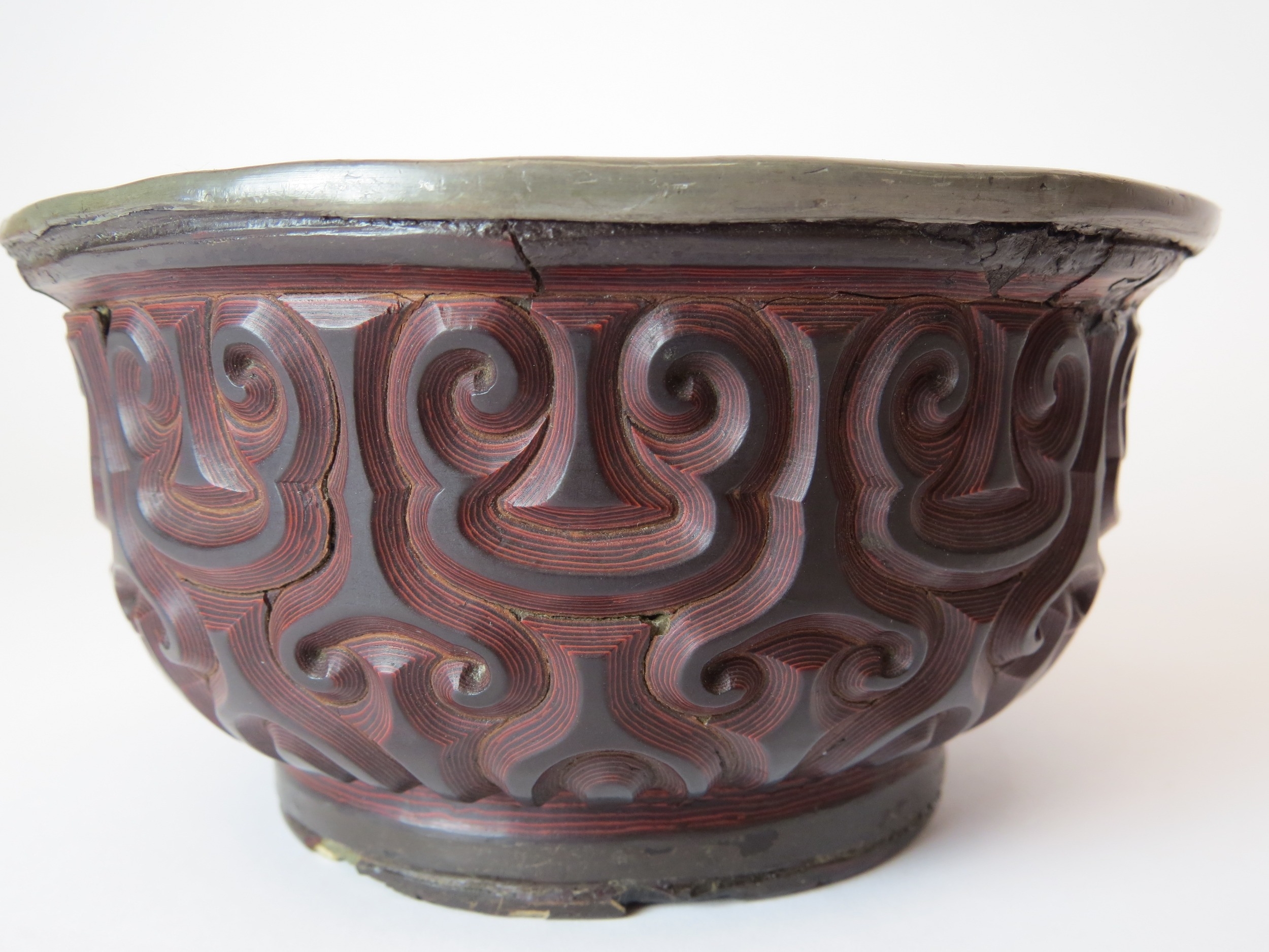 A Chinese tixi 'guri' lacquer pewter lined footed bowl. The red and ...