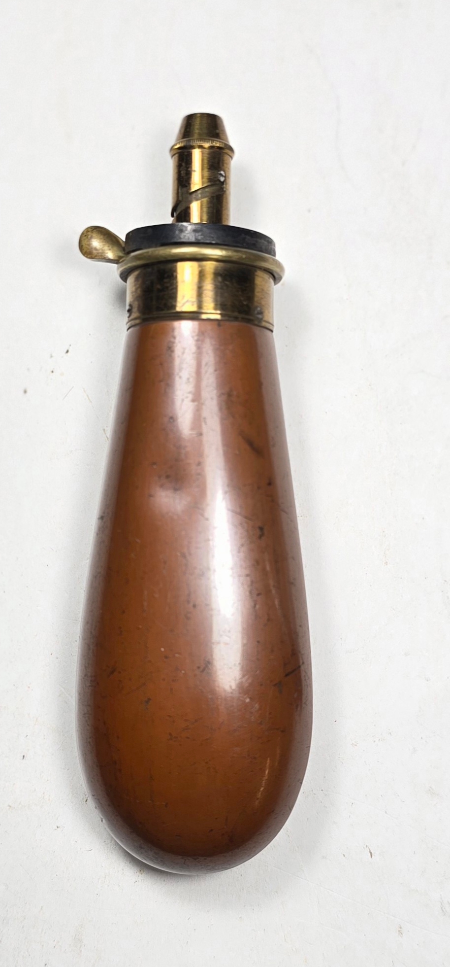 A plain bag-shaped copper powder flask suitable for a cased percussion ...