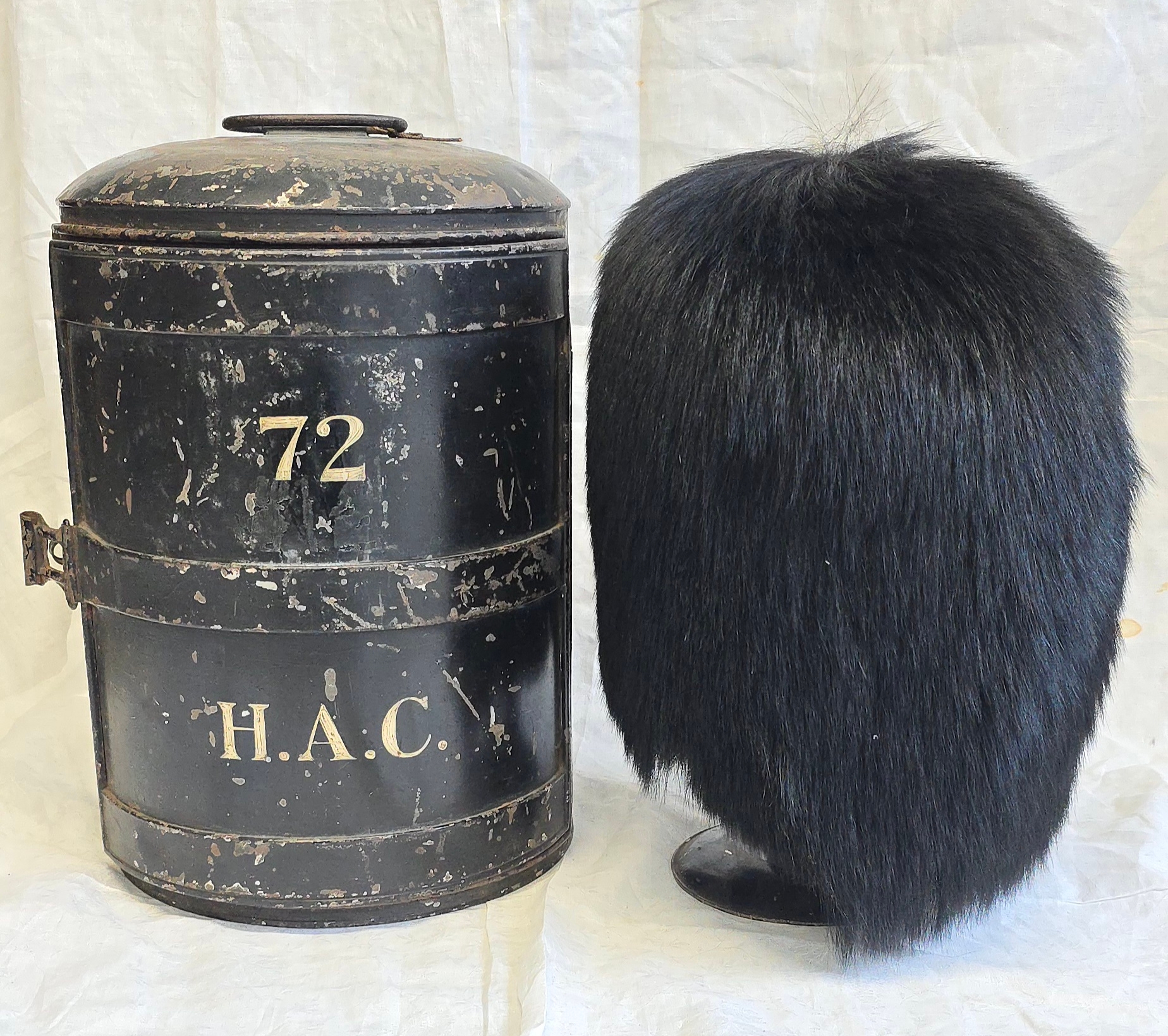 A guards black bearskin cap with tapered brass chin chain, an ER11 ...