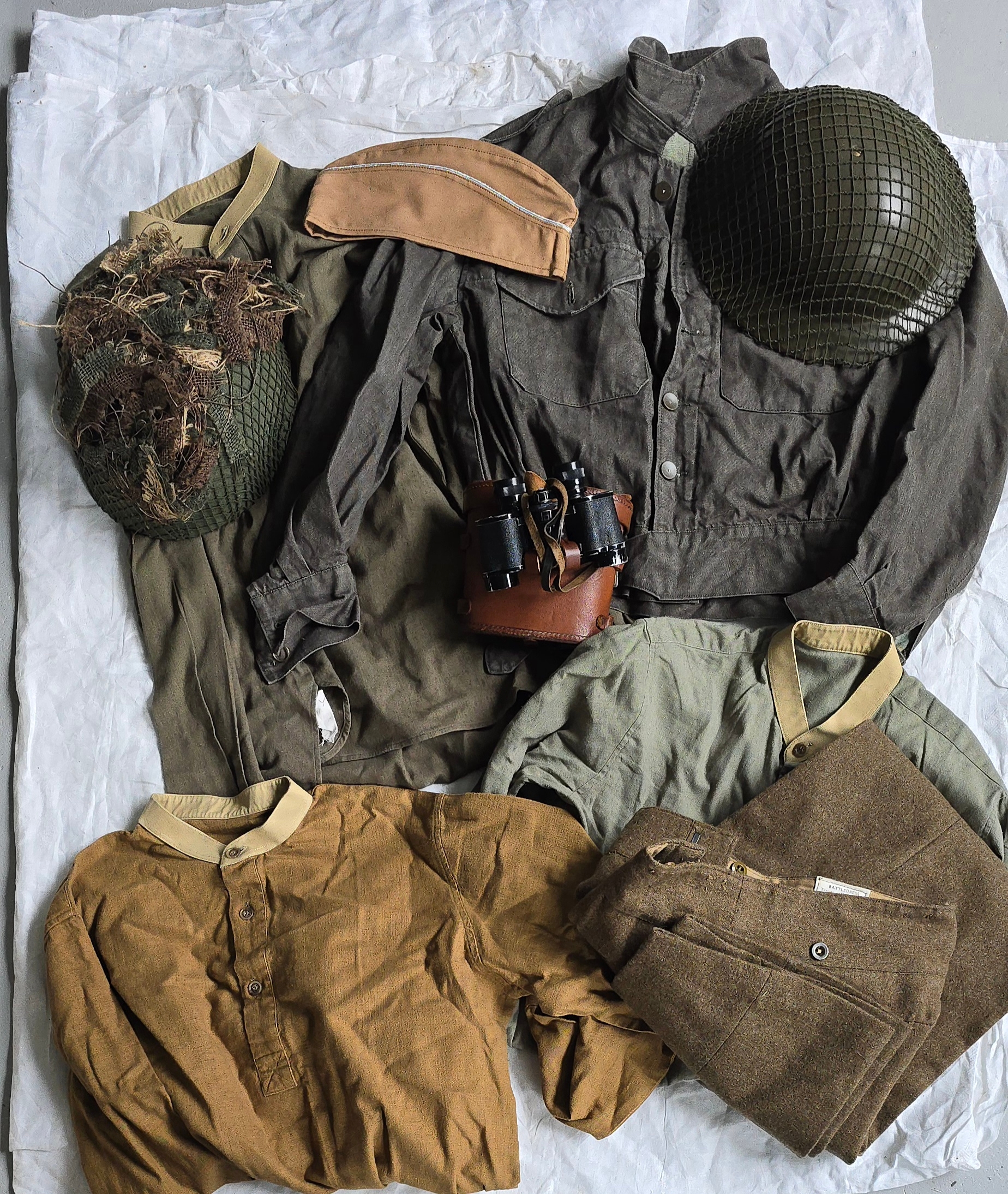 Box of re-enactment uniforms and helmets, 2x British helmets, various ...