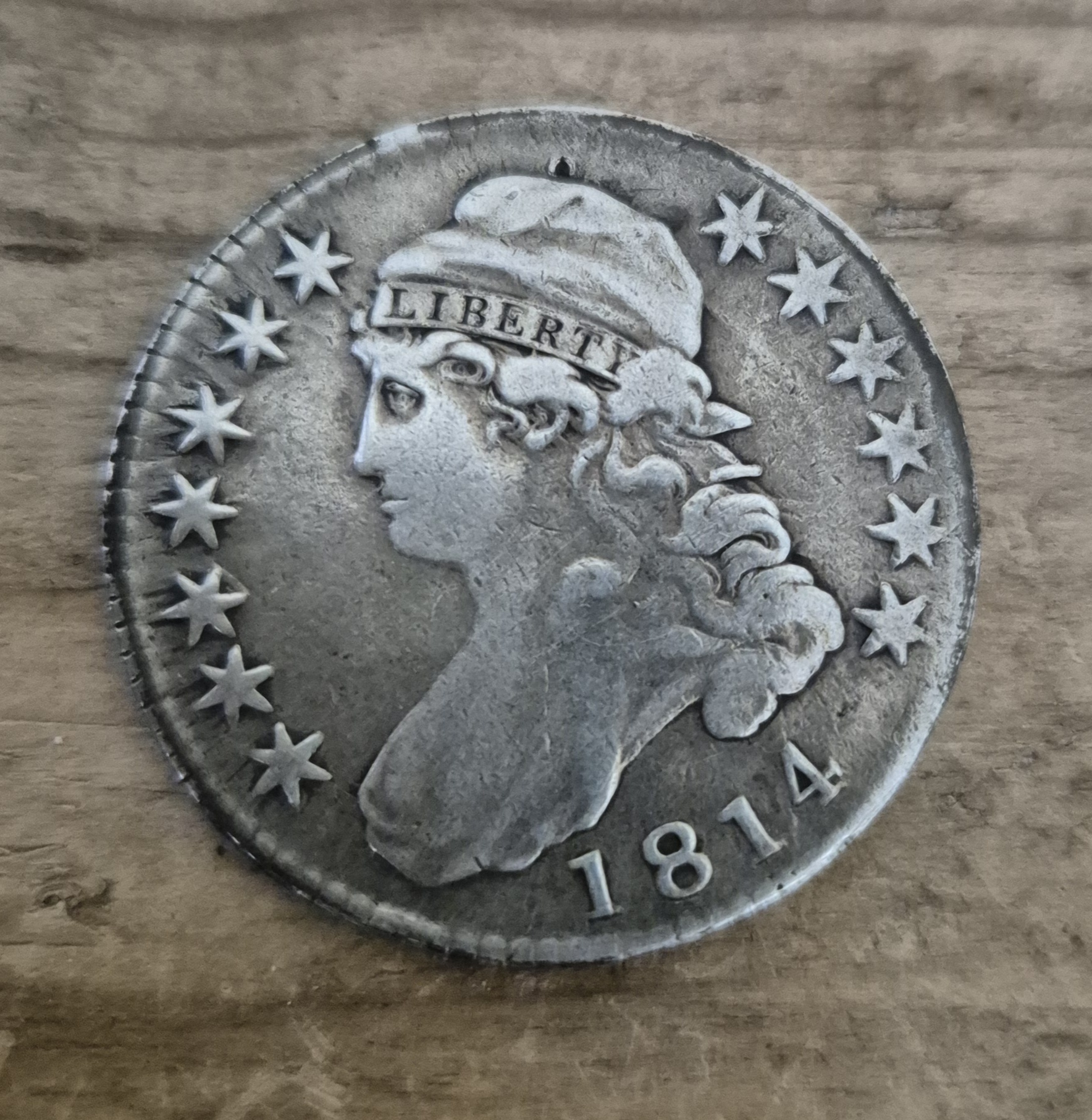 An 1814 USA half dollar, capped bust, e over a.