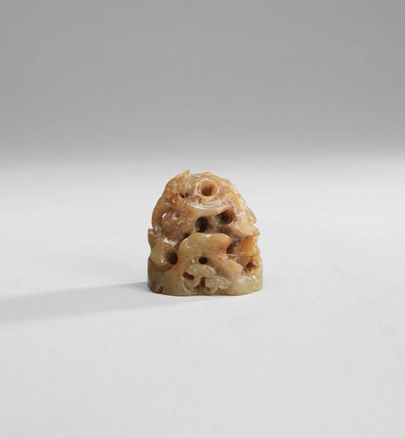 A CHINESE BROWNISH-CELADON JADE FIGURAL HAT FINIAL PROBABLY QING ...