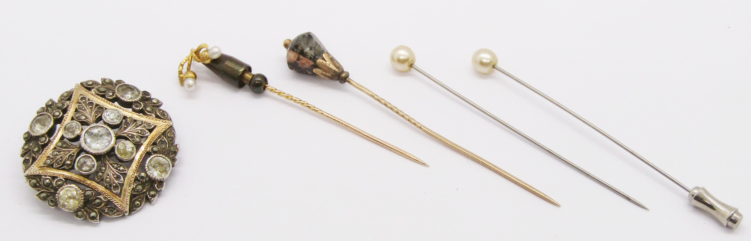 Four various stick pins to include a yellow metal and seed pearl-set ...