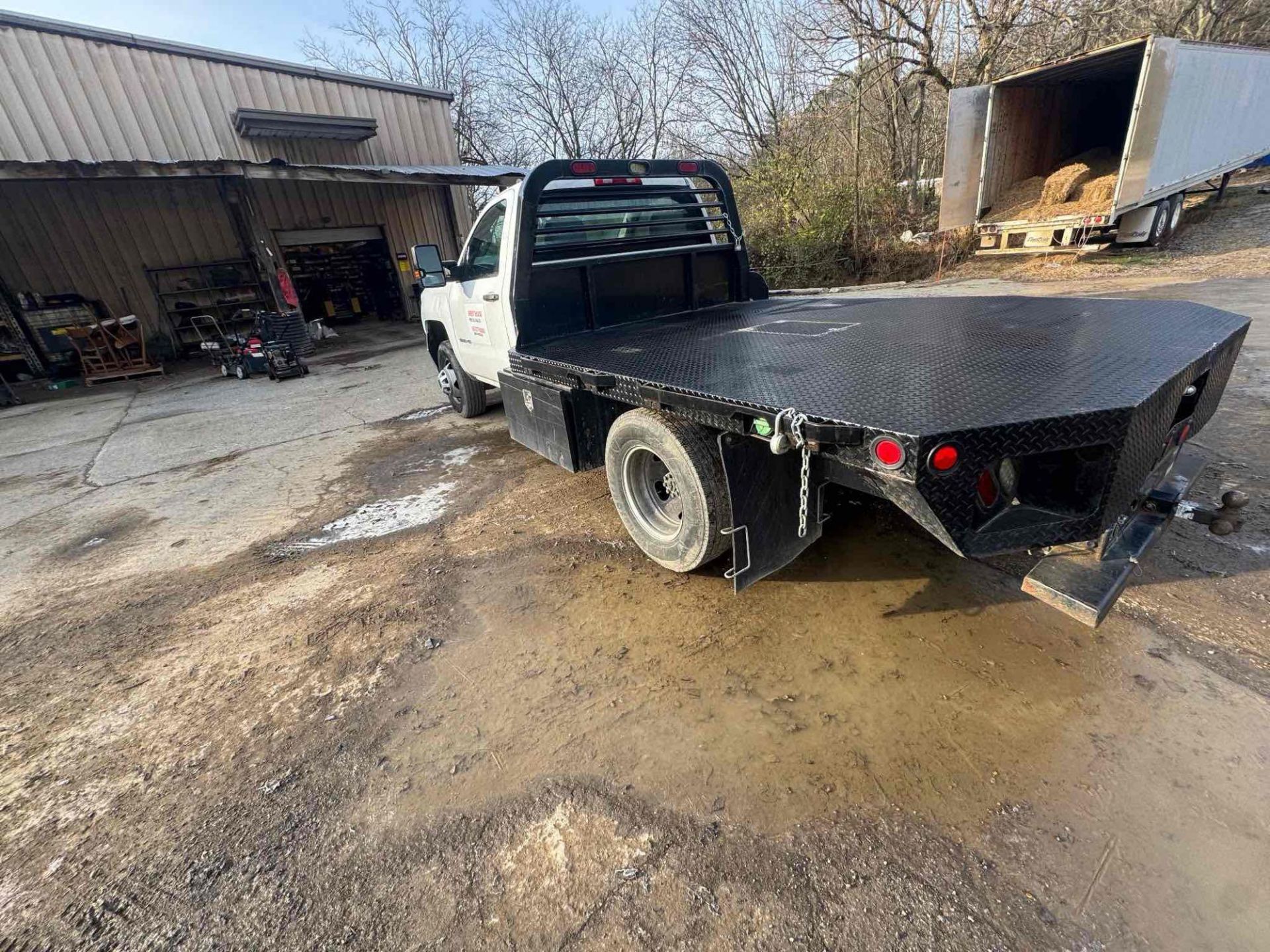 Flatbed delivery truck is a 2018 Chevrolet 3500 with 140,829 miles