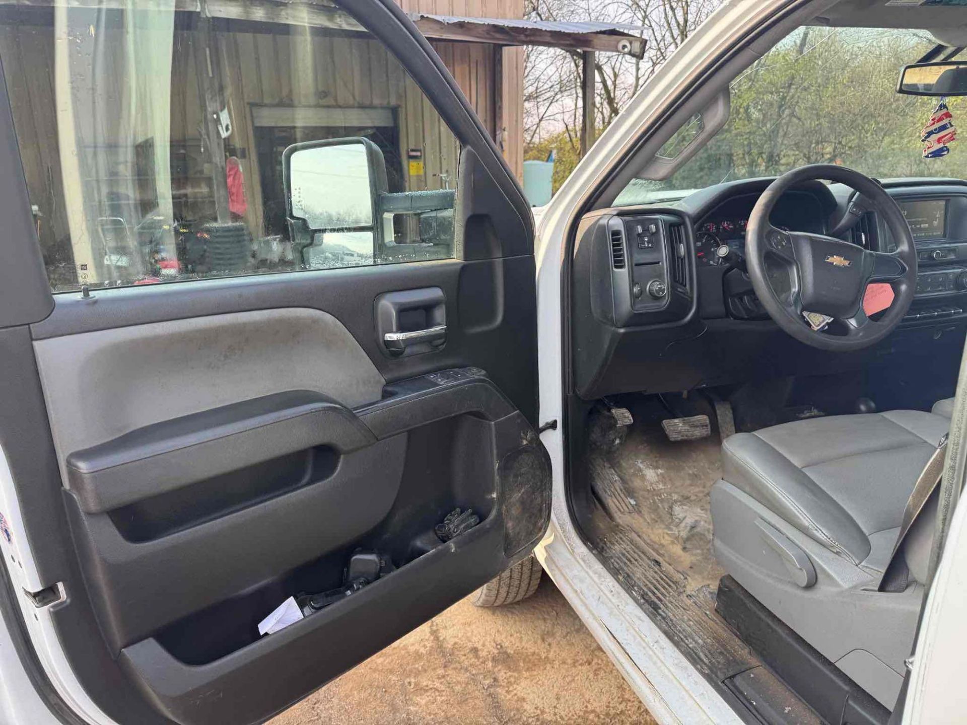 Flatbed delivery truck is a 2018 Chevrolet 3500 with 140,829 miles