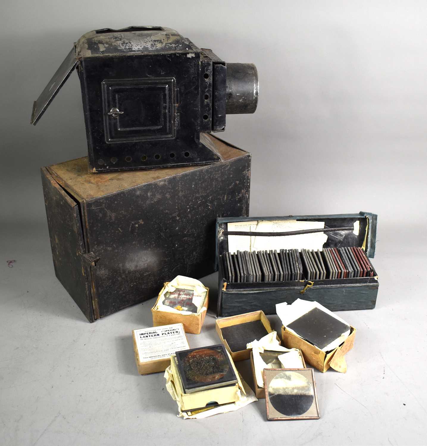 An antique magic lantern viewer together with a large quantity of glass ...