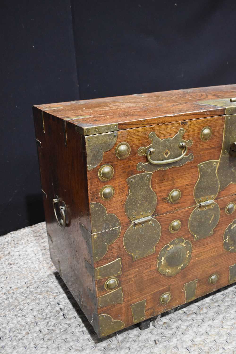 A Korean elm and brass mounted bandaji chest, with twin brass handles ...