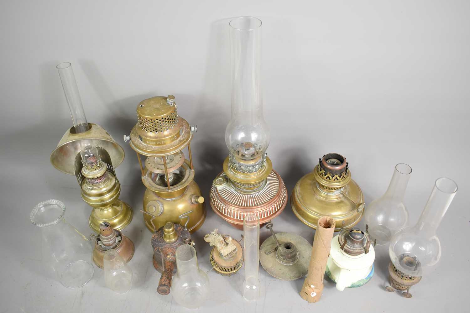 A collection oil lamps, glass chimneys and spares, to include a Hinks ...