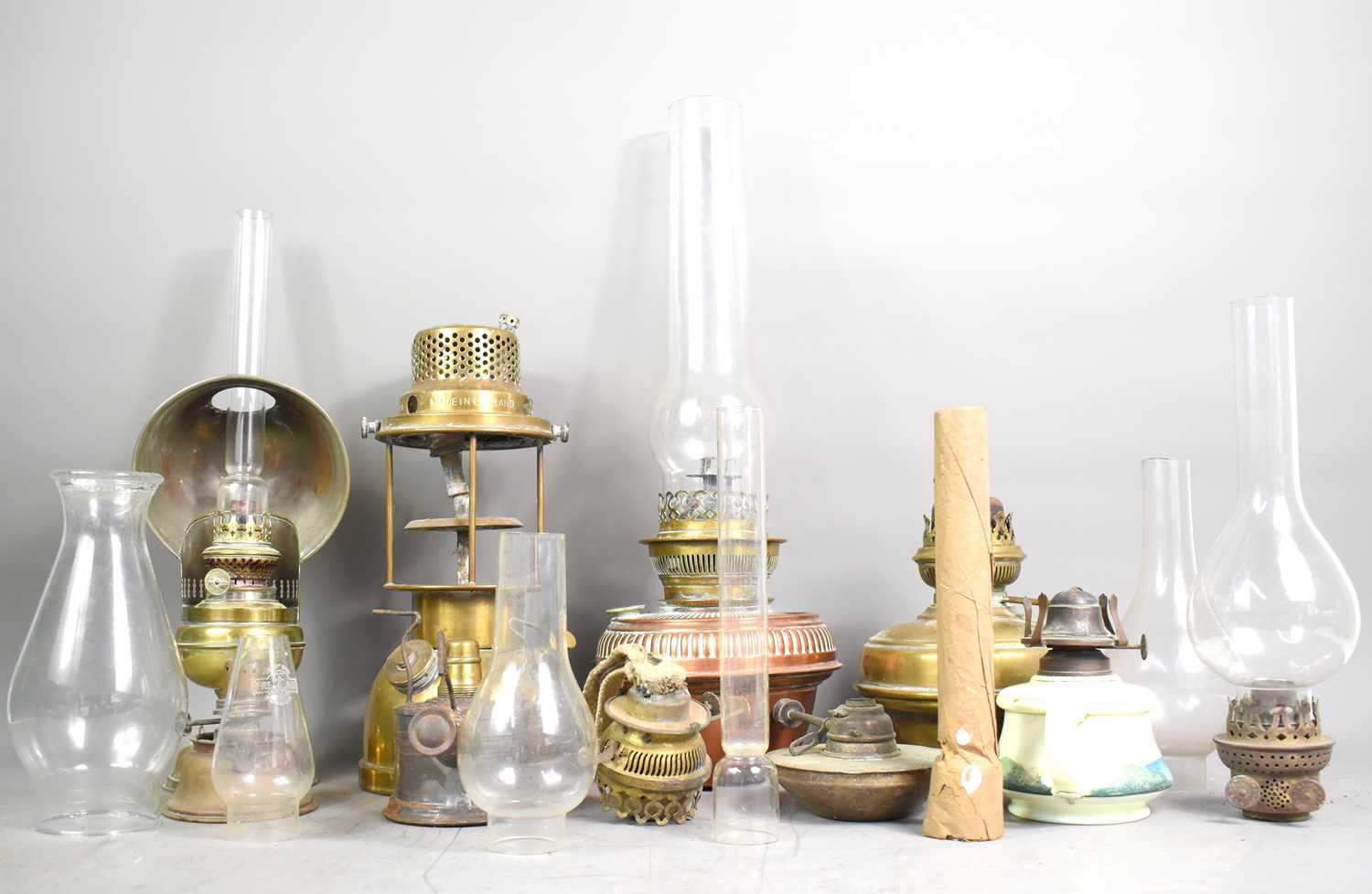 A collection oil lamps, glass chimneys and spares, to include a Hinks ...