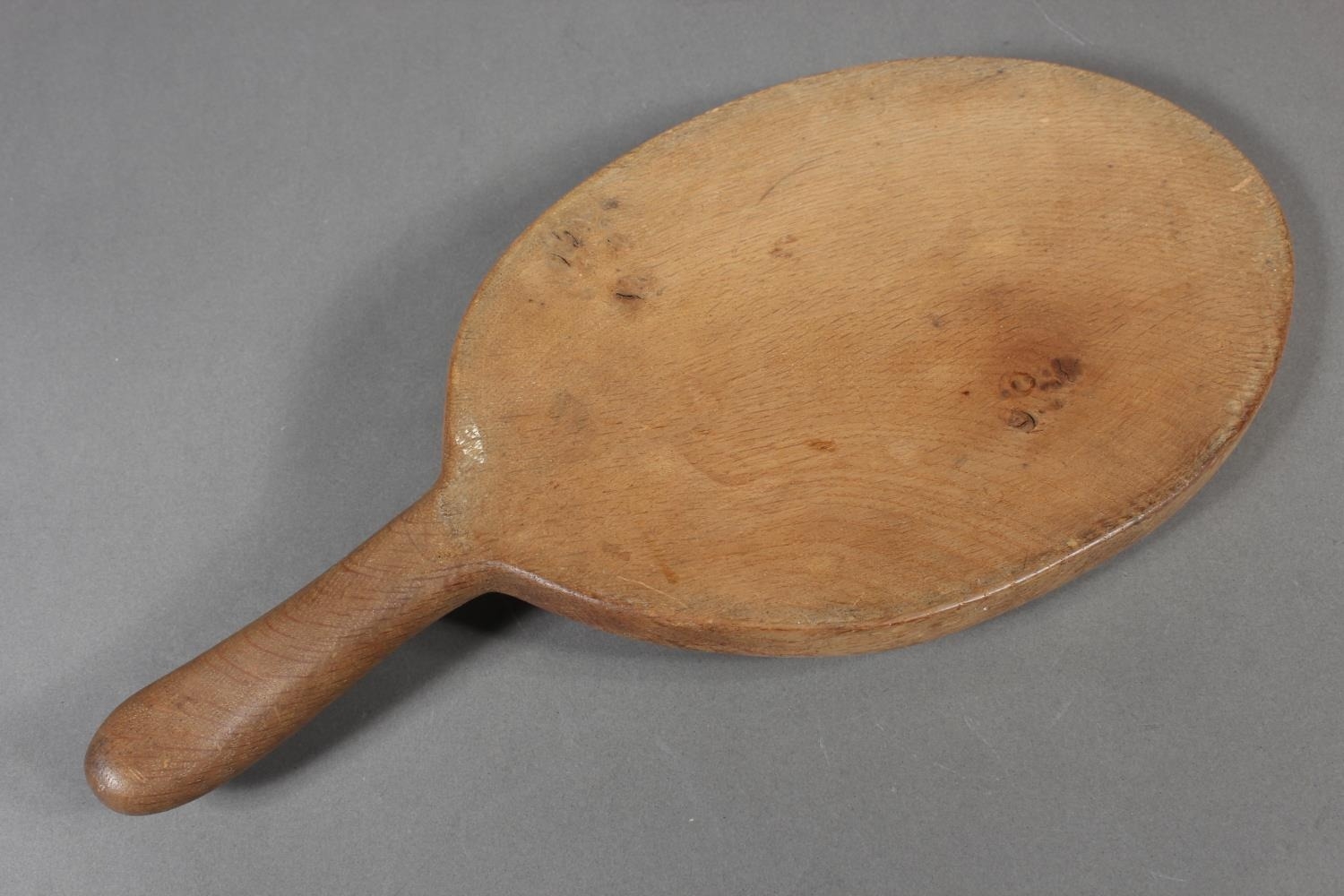 Robert Mouseman Thomson oak cheese board, of oval form with raised ...