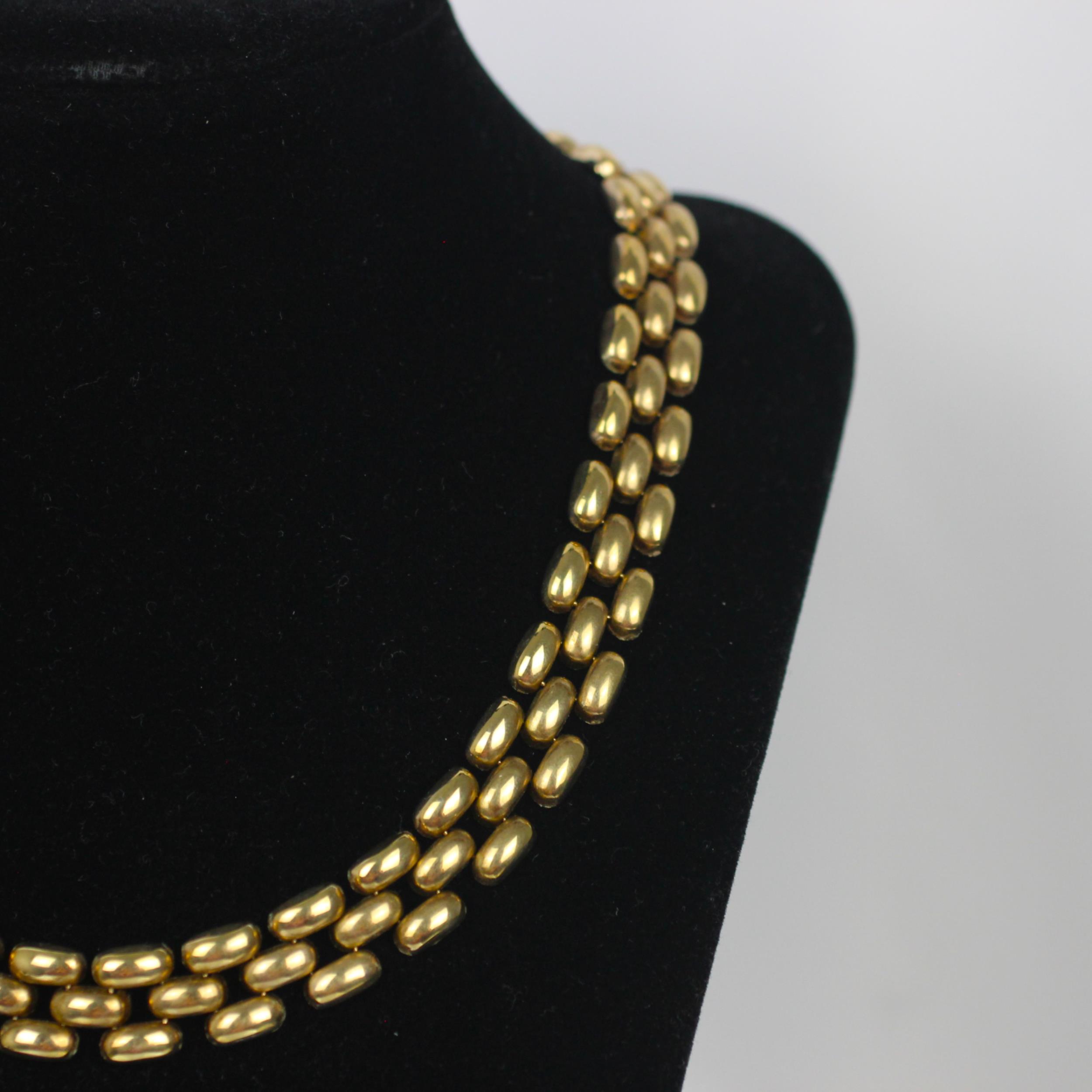 A late 20th century Italian 9ct gold collarette, the hollow stylised ...