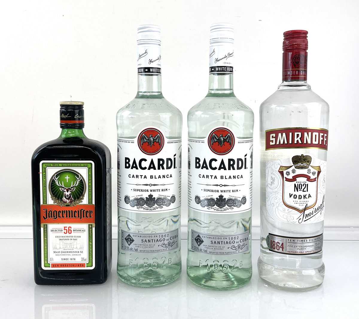 +VAT 4 bottles, 1x Smirnoff No21 Vodka 37.5% 1 litre, 2x Bacardi Carta ...