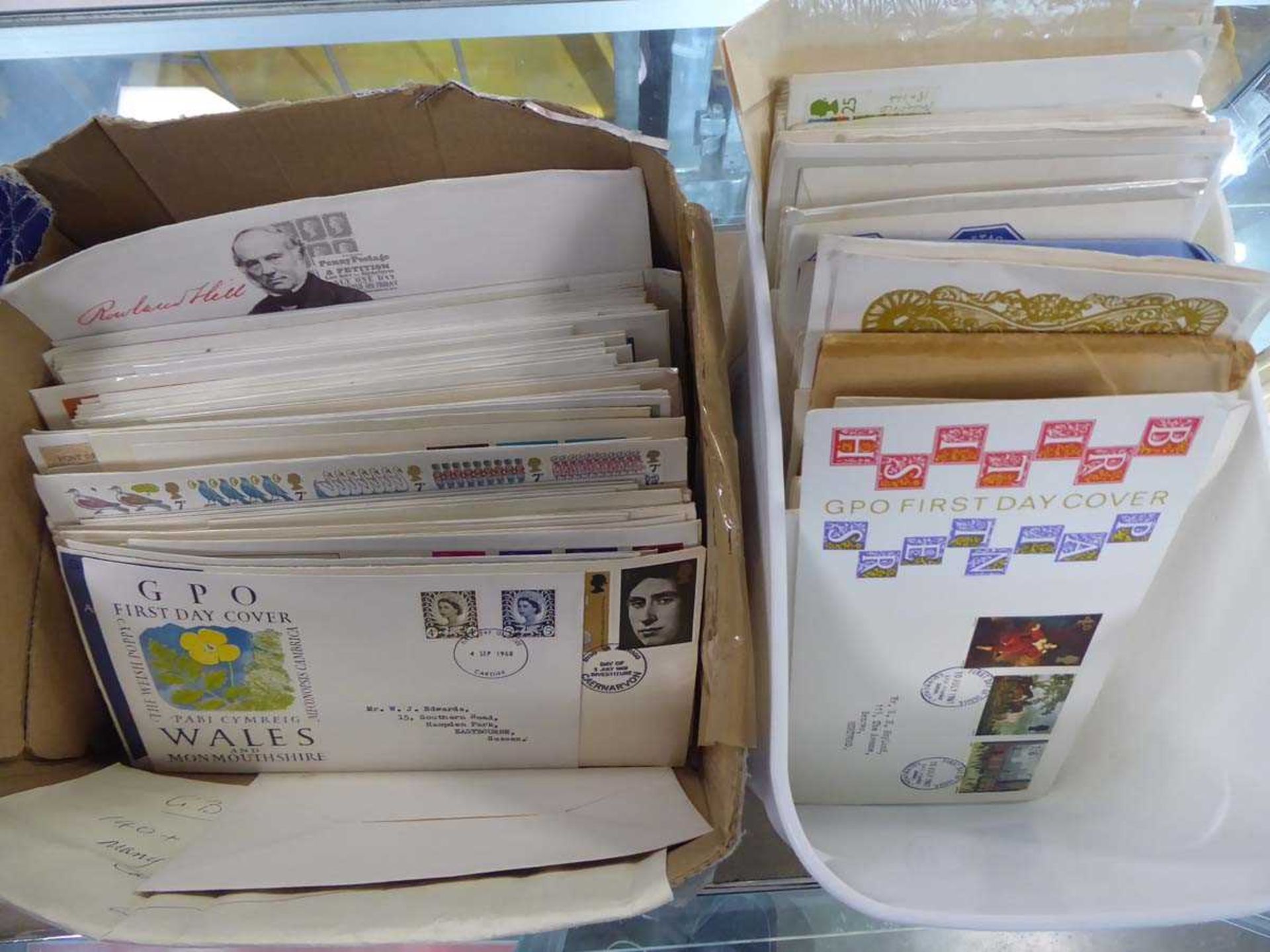 2 boxes containing stamps and First Day covers