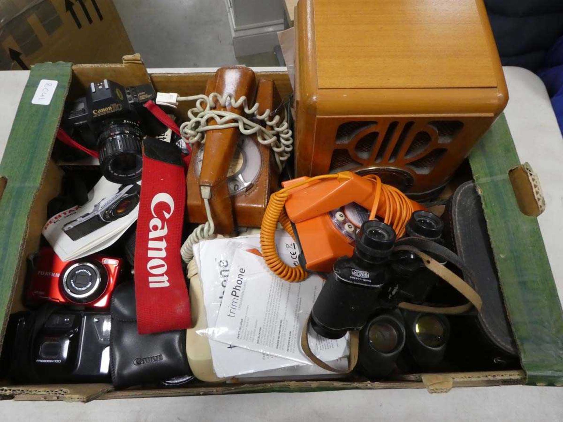 Box containing various cameras, phones etc