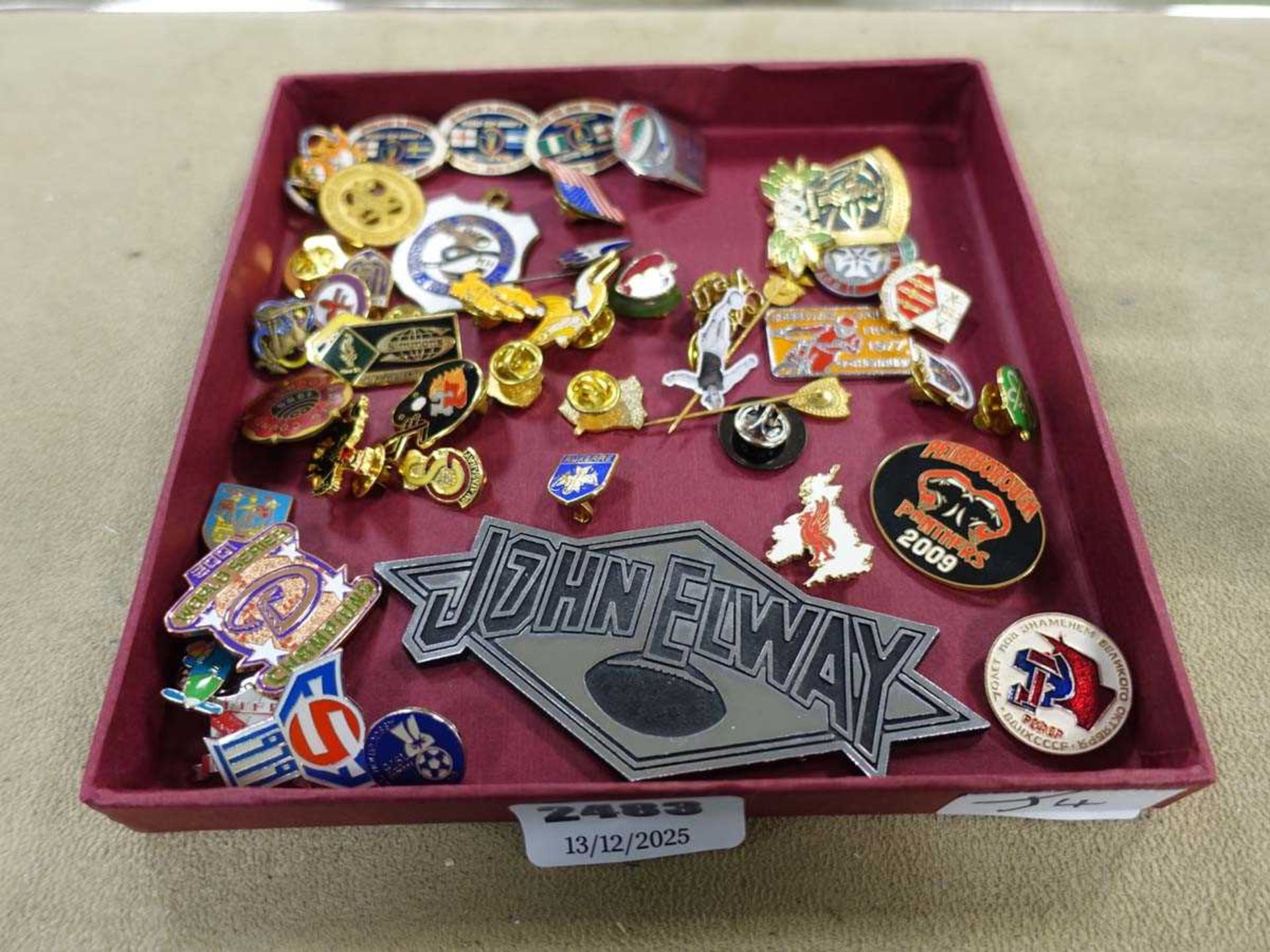 Box containing various badges