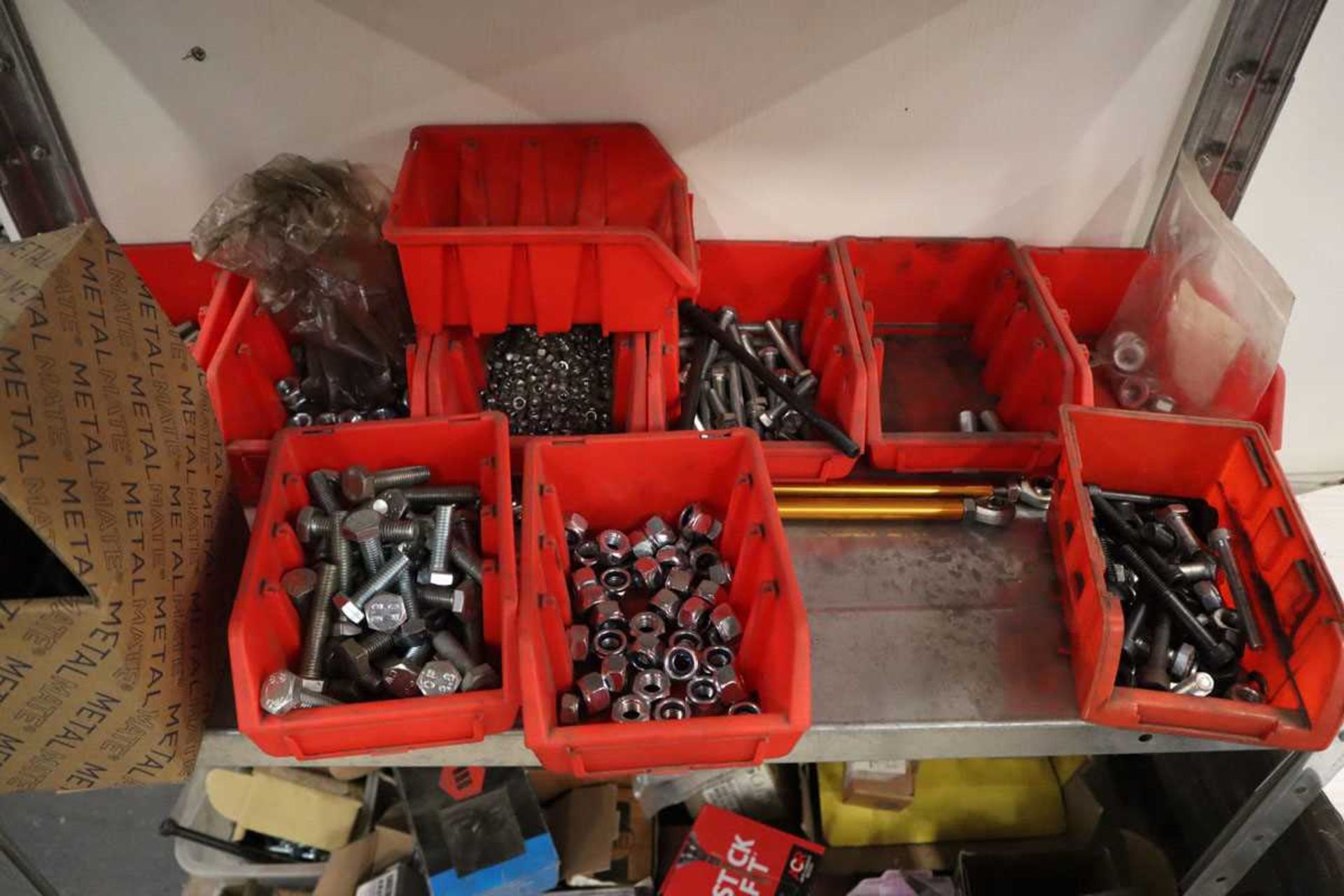 Rack of lin bins containing nuts, bolts, washers and other fixings ...
