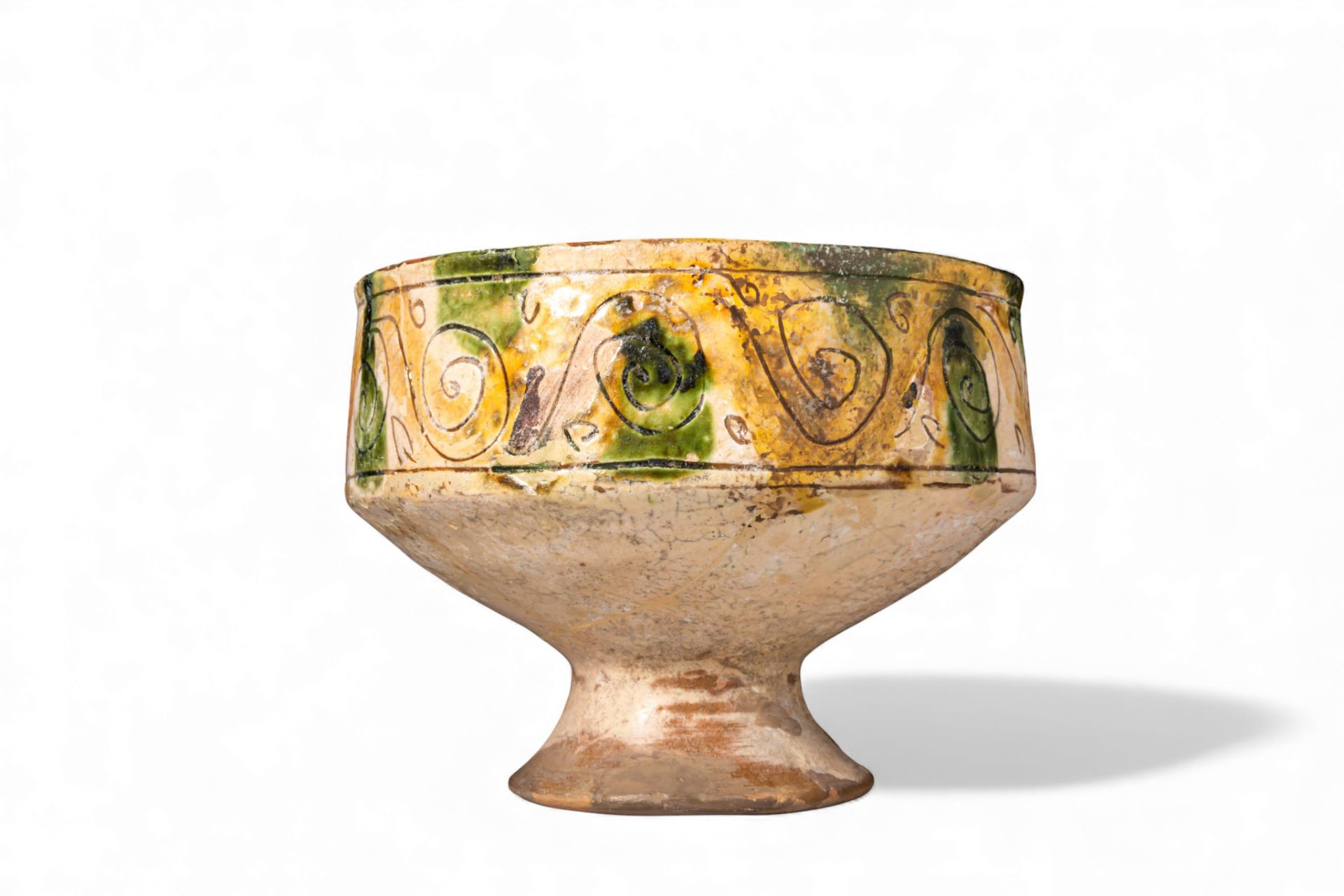Ca. AD 1300 - 1400 A sgraffito ware footed cup with a broad bowl rising ...