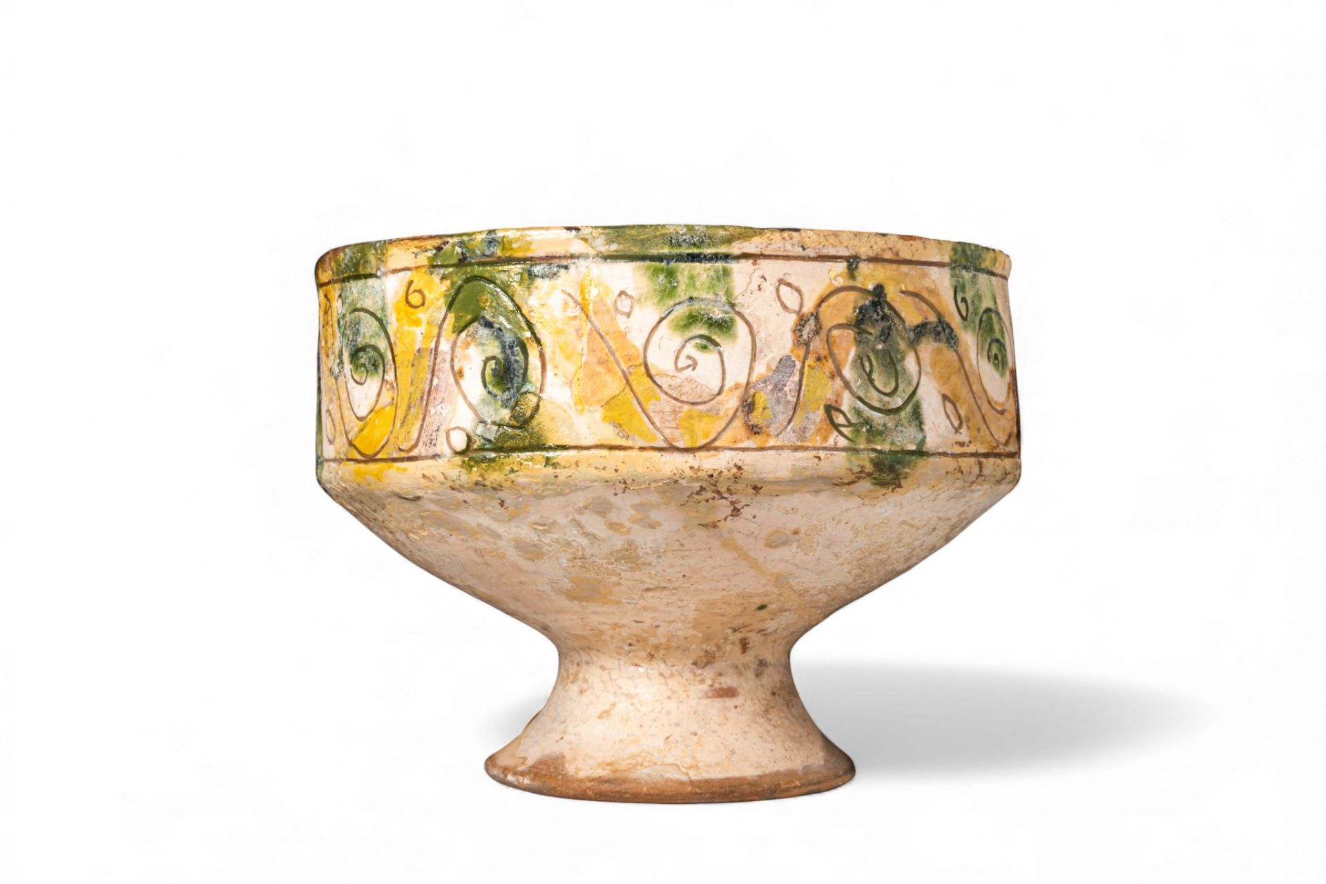 Ca. AD 1300 - 1400 A sgraffito ware footed cup with a broad bowl rising ...