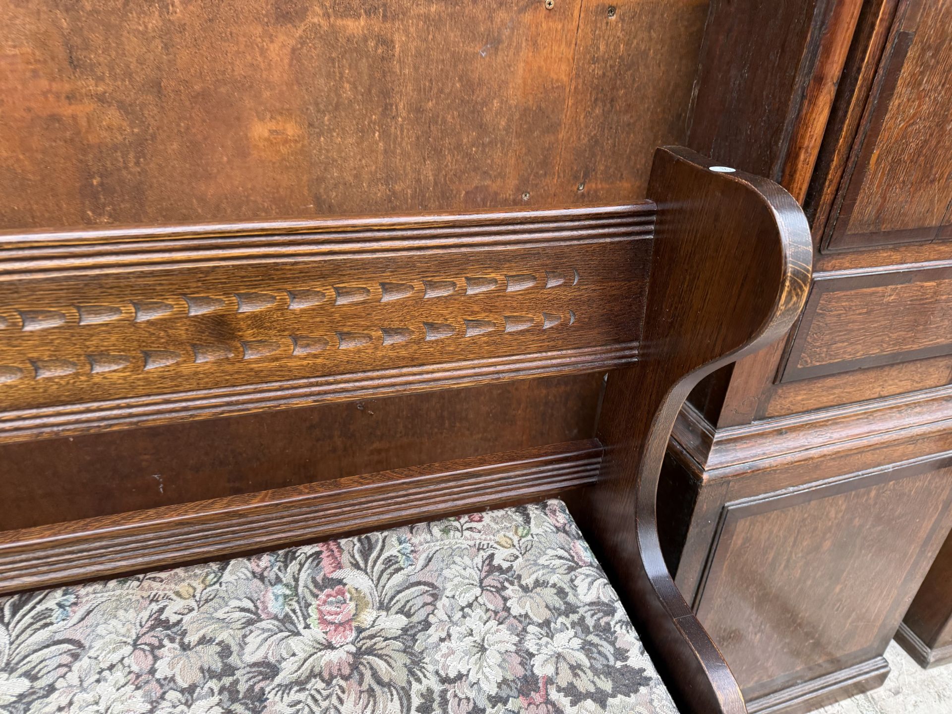 A JACOBEAN STYLE OAK BOX SETTLE WITH CARVED FRONT PANEL AND TOP RAIL ...
