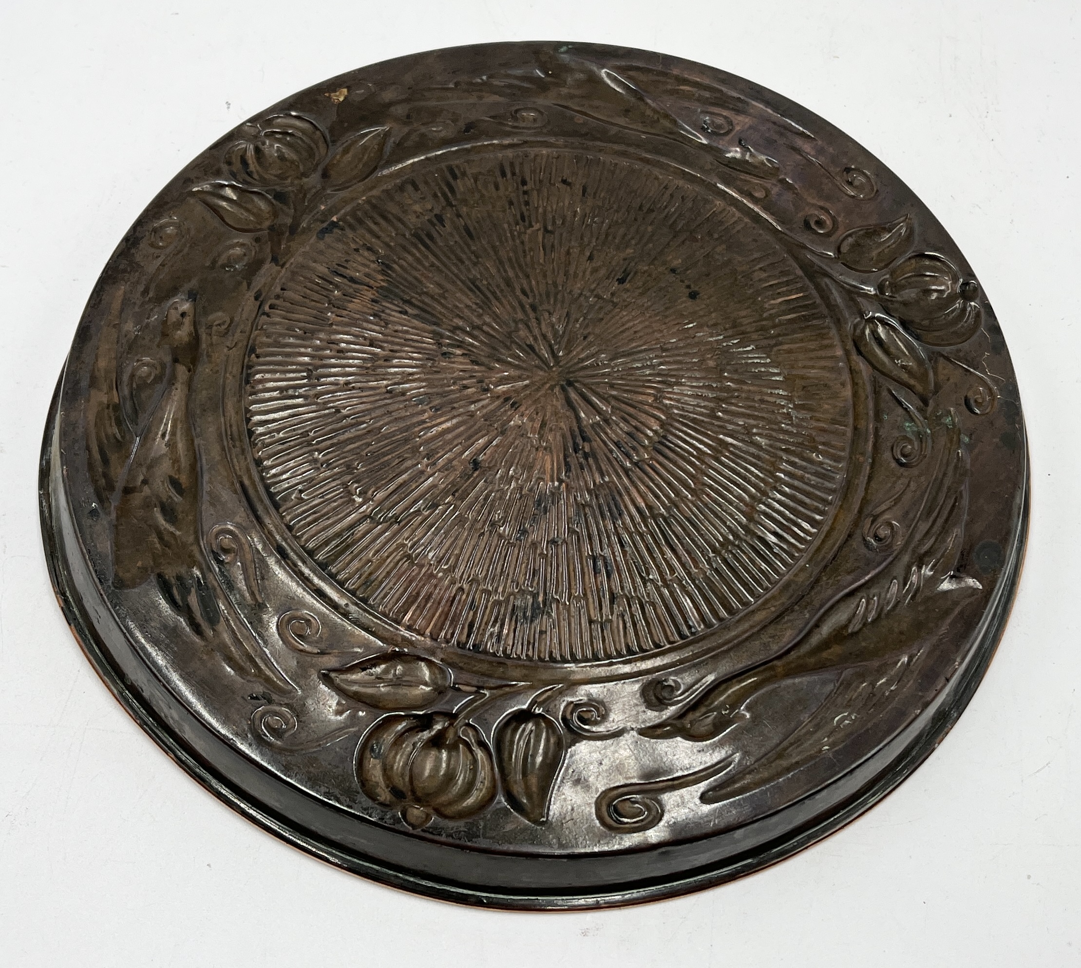 An Arts and Crafts hammered copper tray decorated with birds and ...