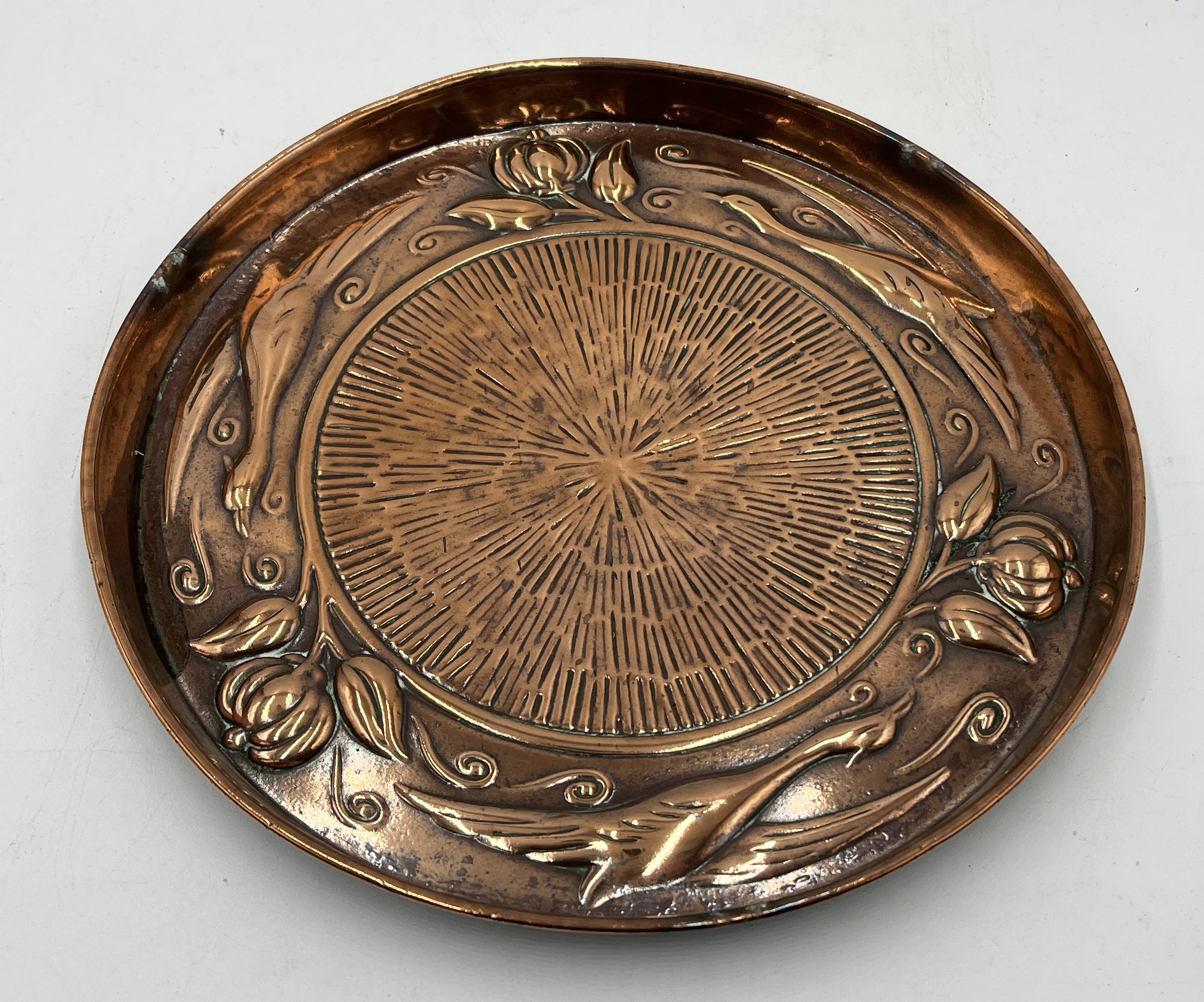 An Arts and Crafts hammered copper tray decorated with birds and ...