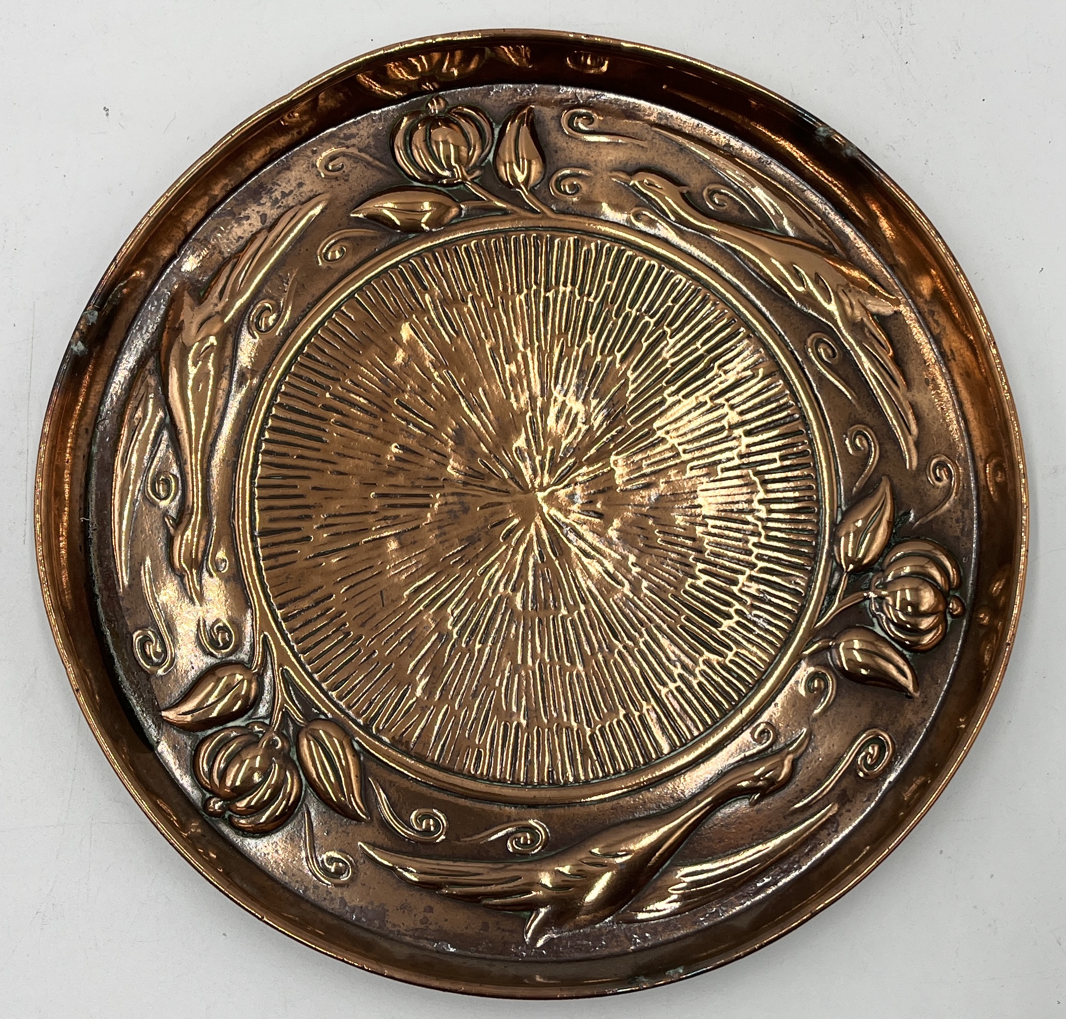 An Arts and Crafts hammered copper tray decorated with birds and ...