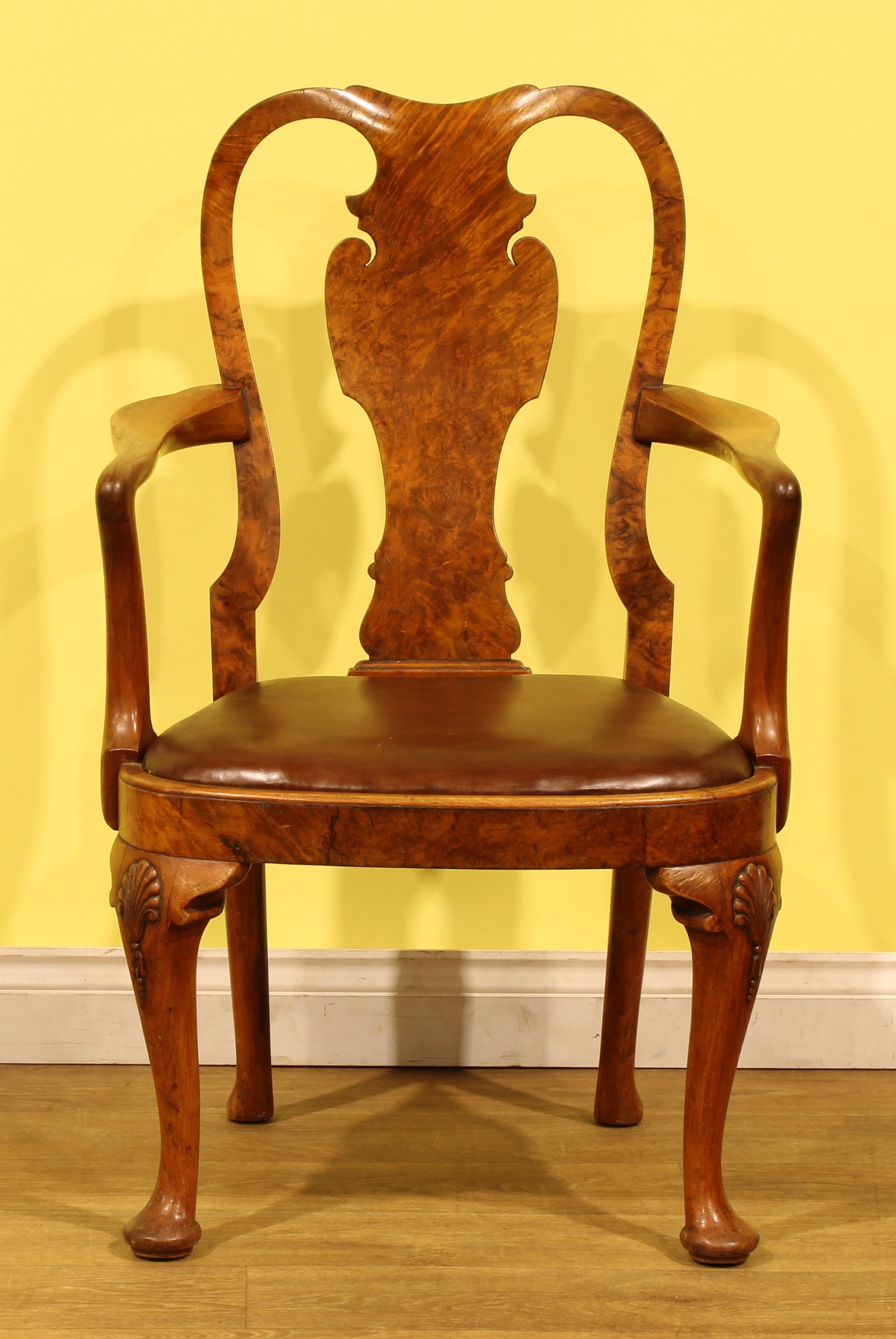 A set of eight Queen Anne Revival walnut dining chairs, comprising six ...